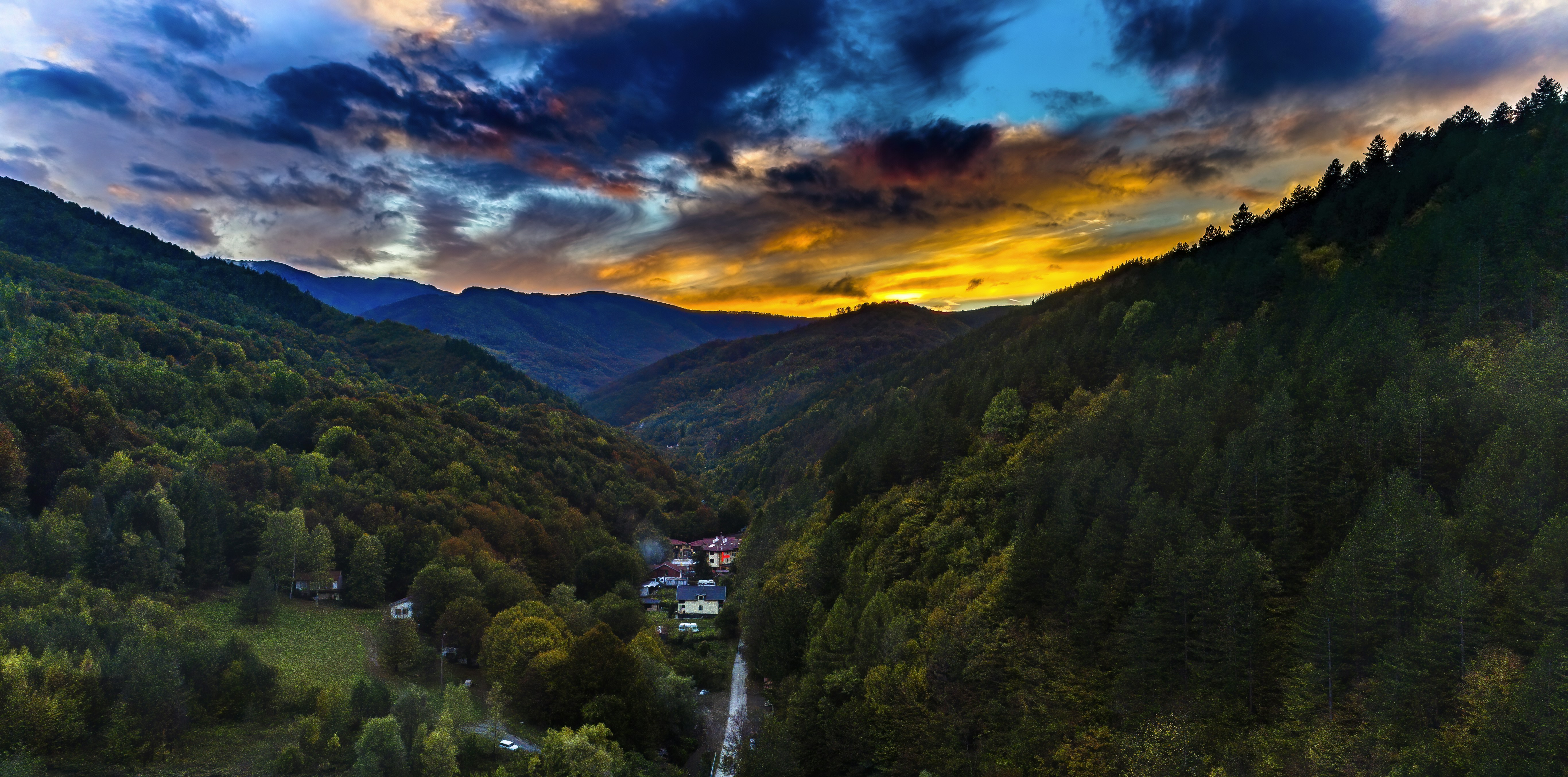 Ember-lit Valley: Sunset Over a Quiet Village Among the Pines