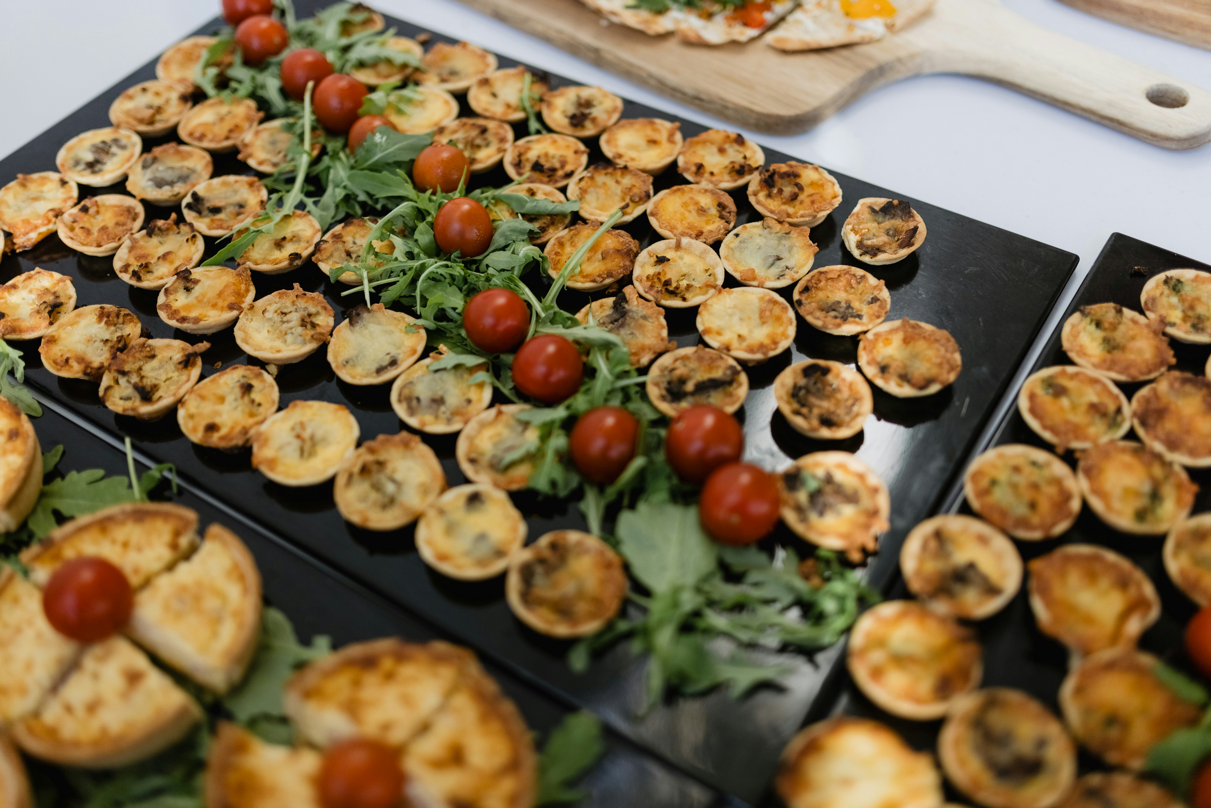 A table topped with trays of food covered in toppings photo – Free ...