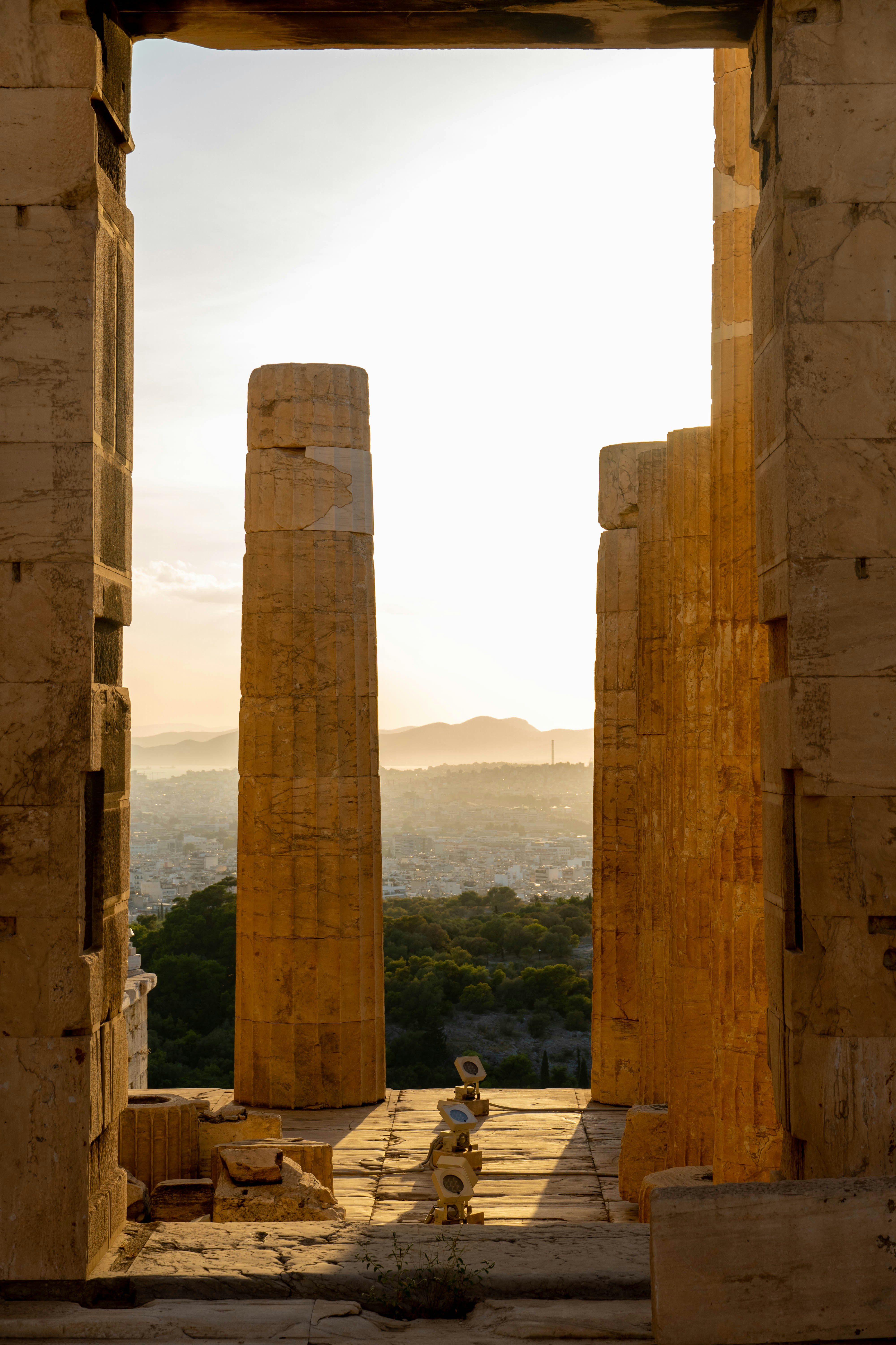 A view of a city through two stone pillars photo – Free Architecture ...
