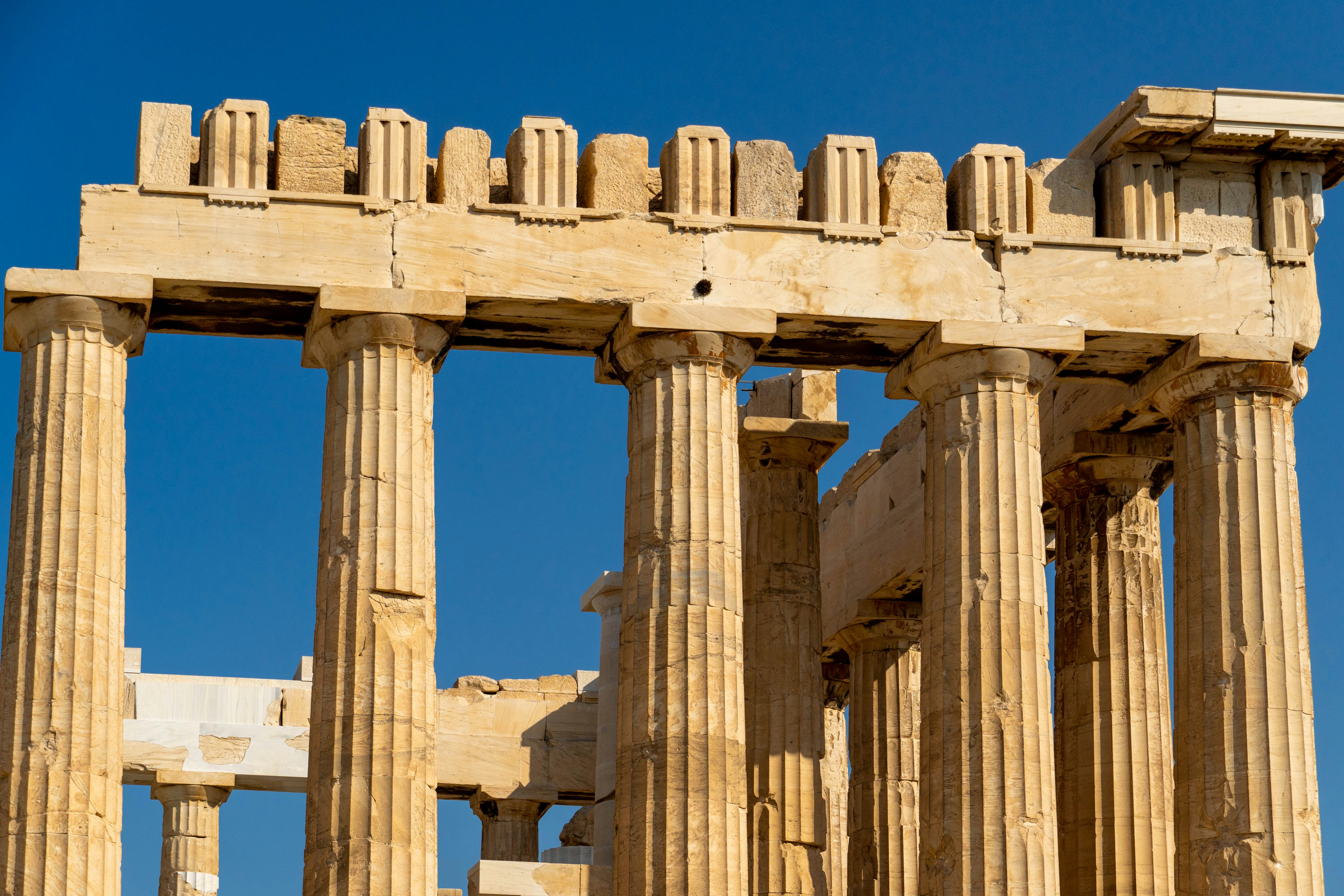 A large stone structure with many columns photo – Free Architecture ...