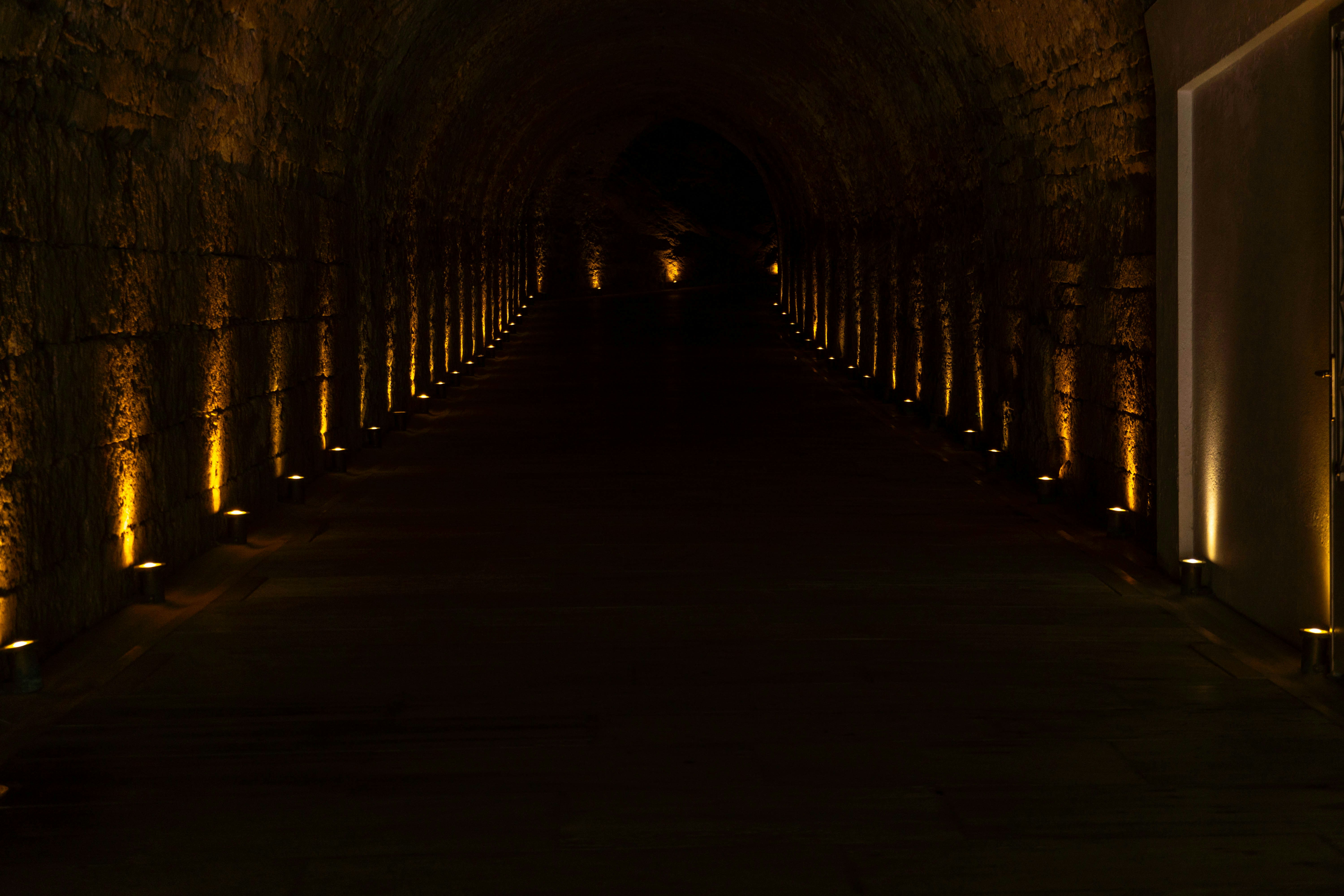 A long tunnel with lights on both sides of it photo – Free Corridor ...