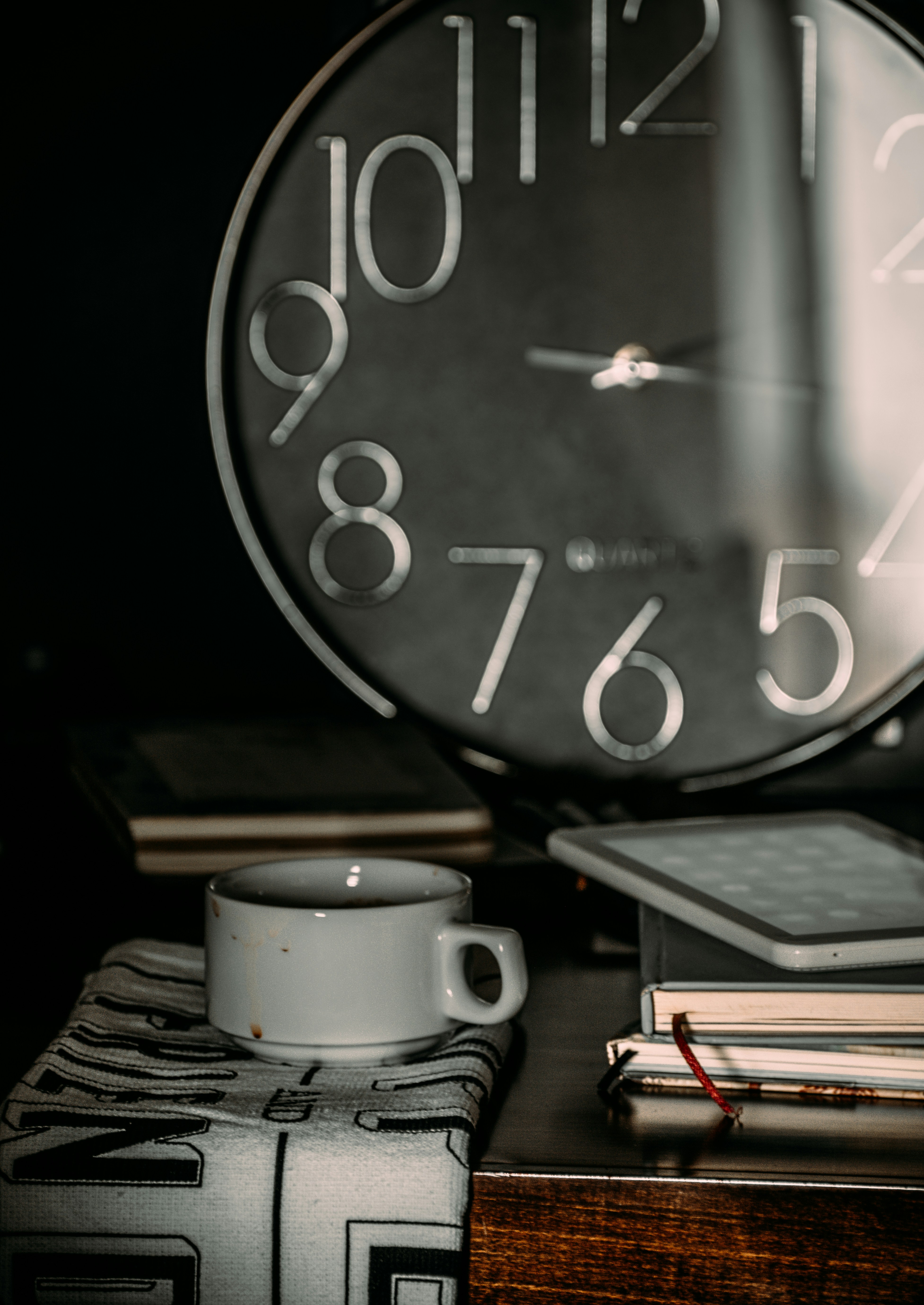 Timely Quiet: A Clock, Coffee, and Notebooks in Focus