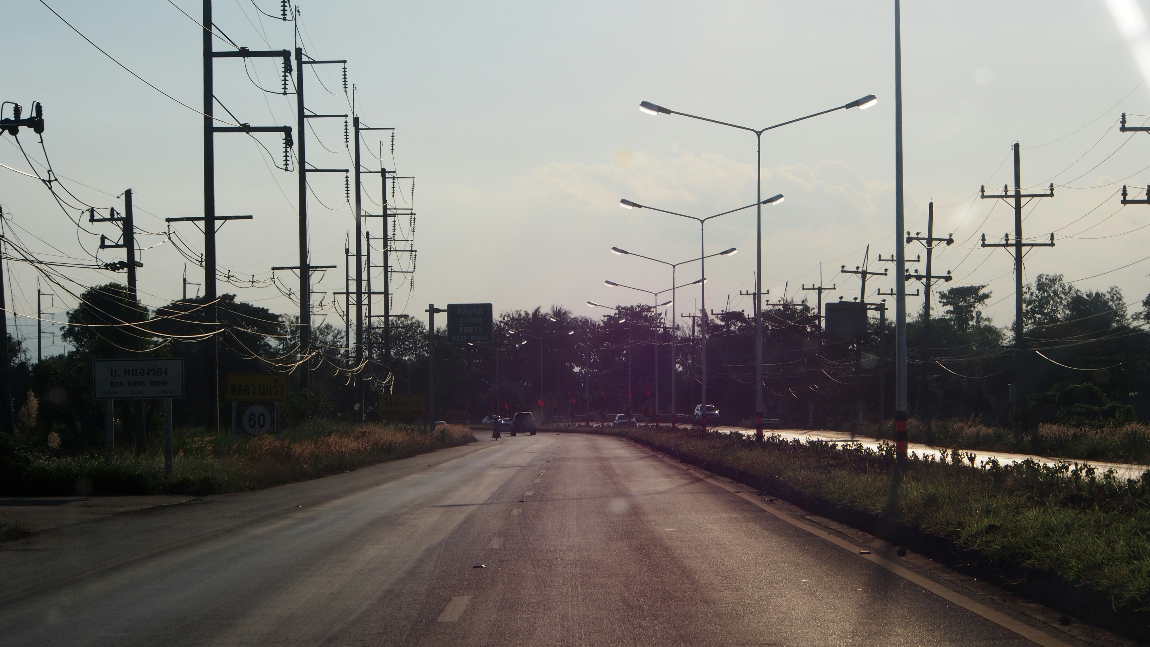 An empty road with lots of power lines above it photo – Free Street ...