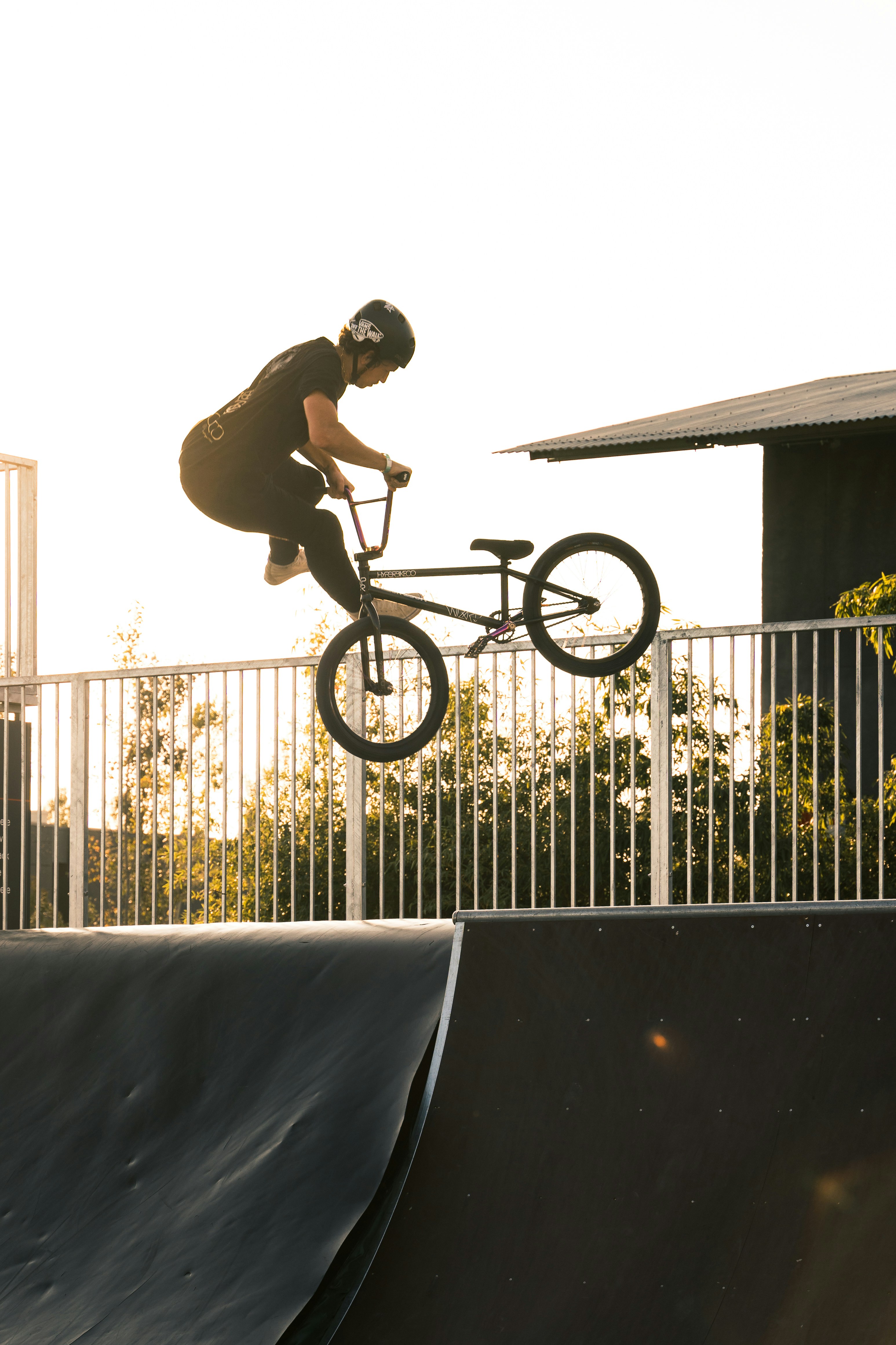 A man riding a bike up the side of a ramp photo – Free Human Image on ...