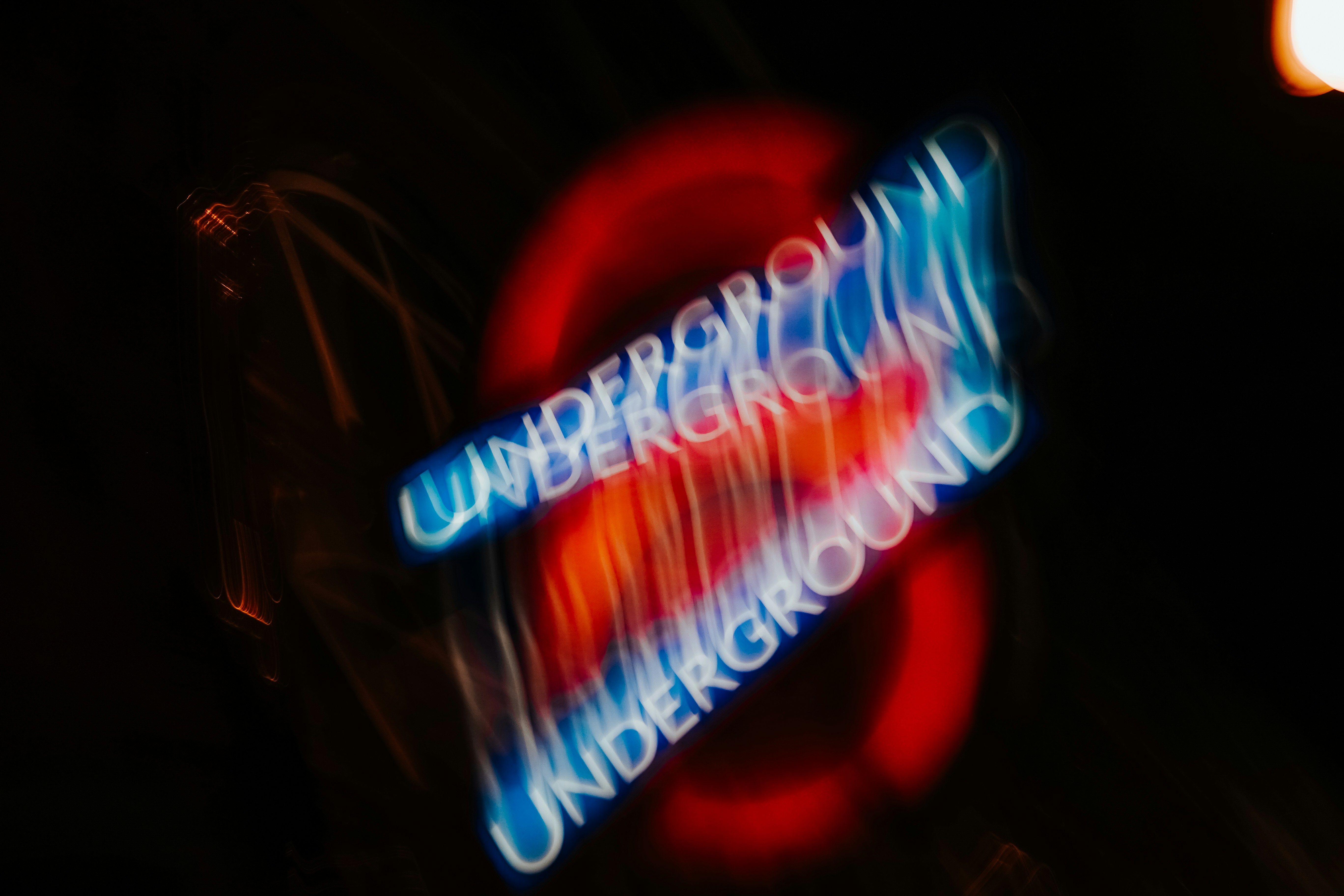 Neon Text in Motion: Blurred Underground Sign Slices