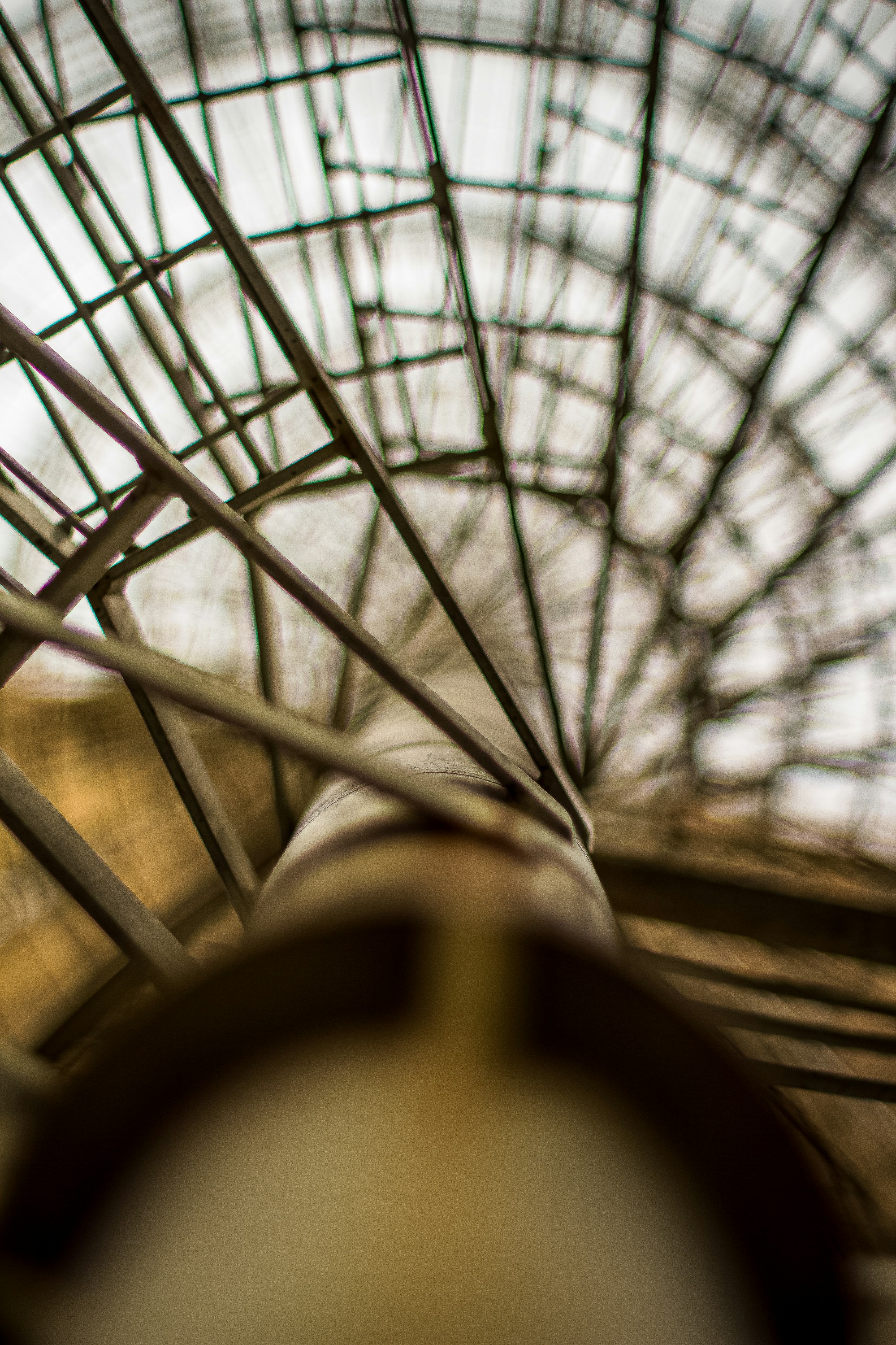 Architectural Spiral: A Tubular Perspective Through a Glass-Chevron Cavern
