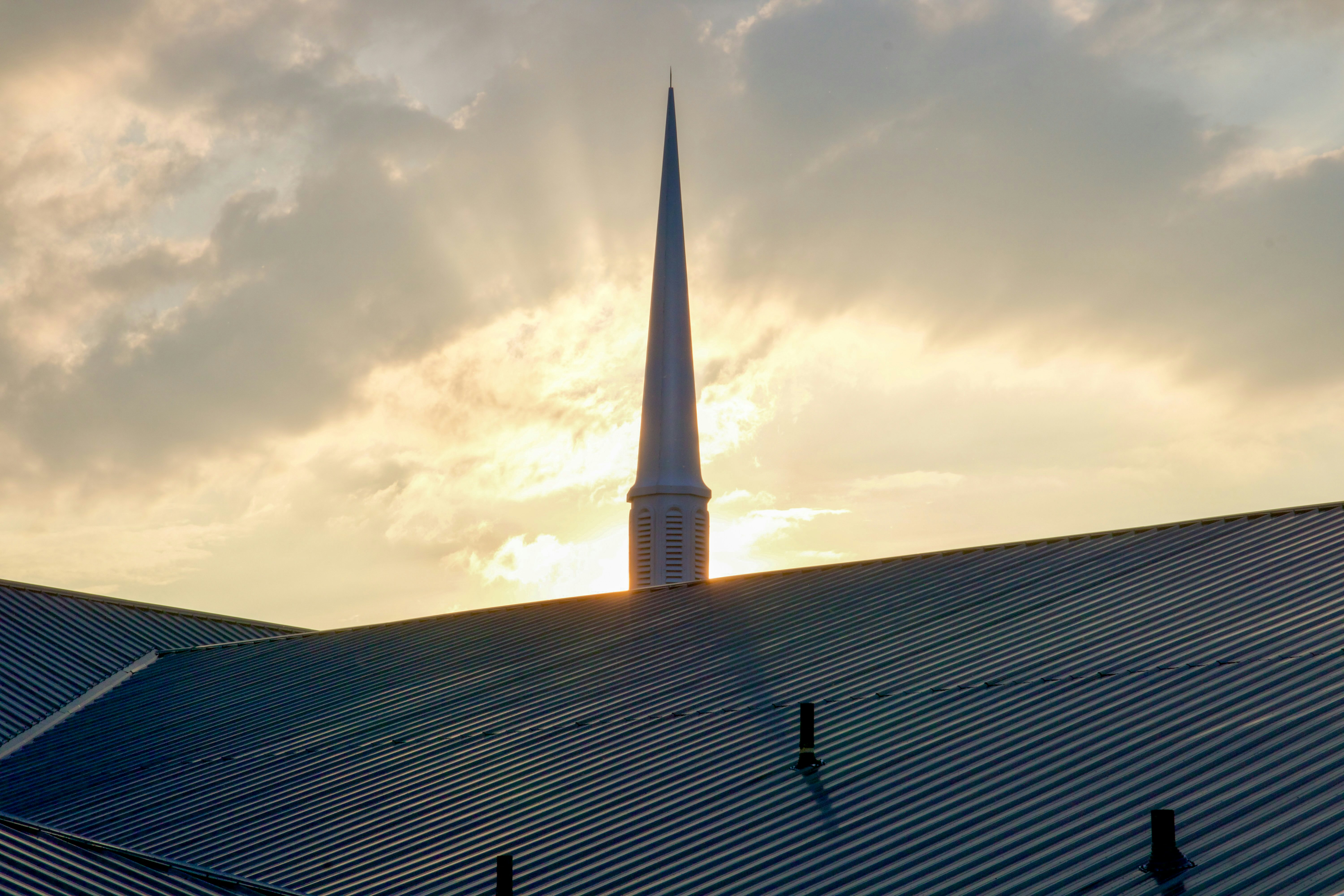 A building with a steeple on a cloudy day photo – Free Building Image ...