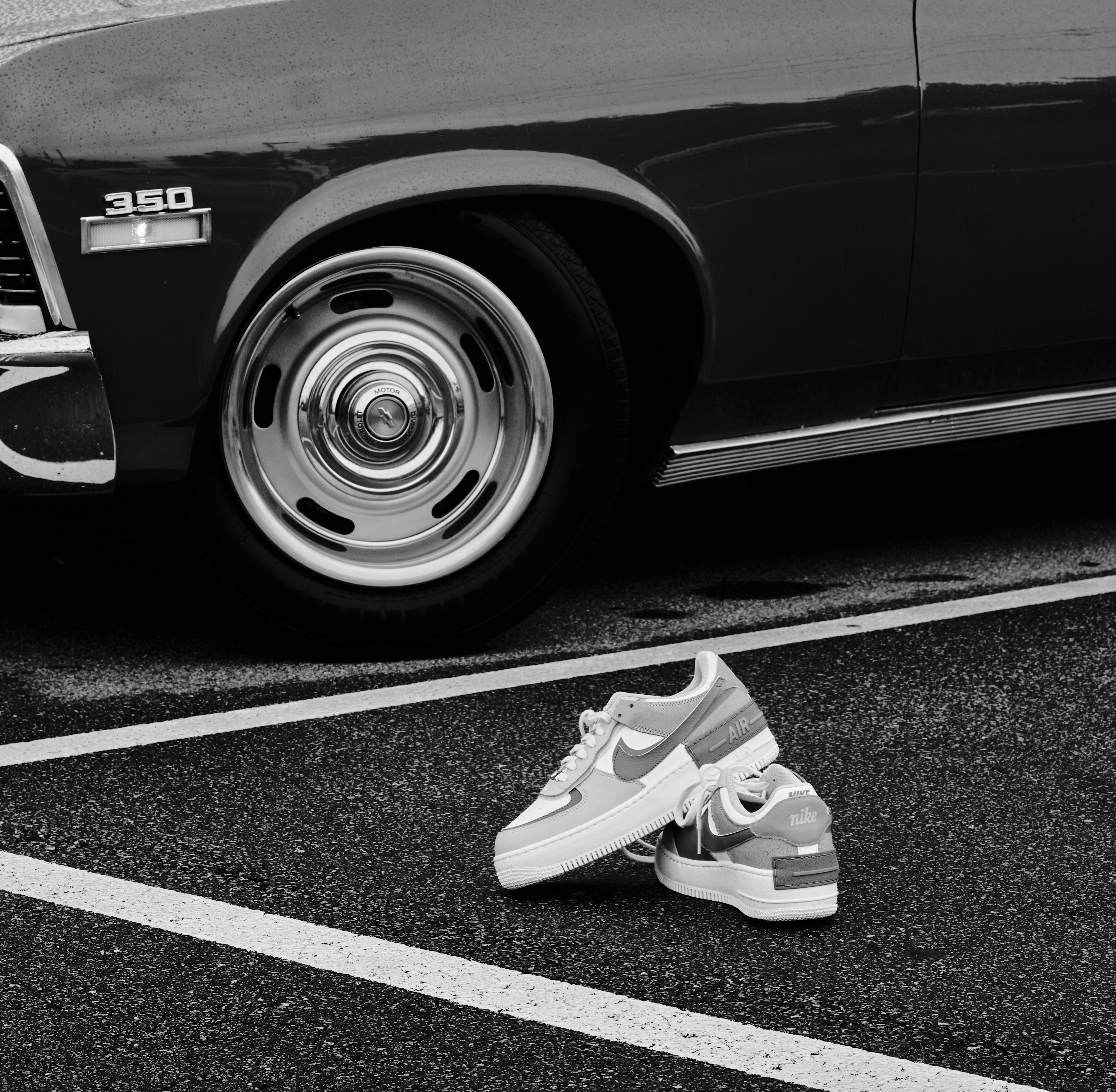 Chrome Wheel and Sneakers: A Quiet Monochrome Moment in Parking Lot