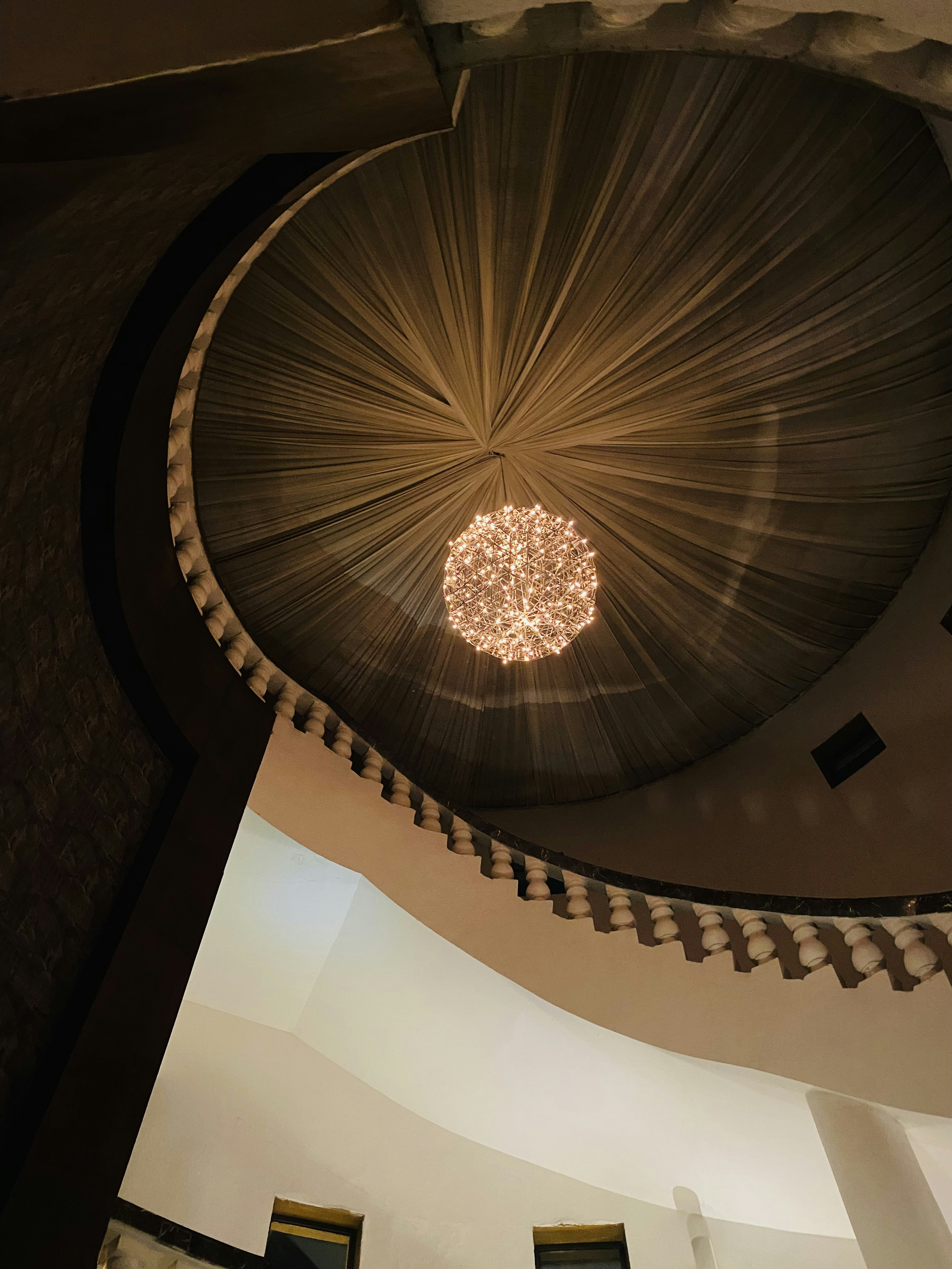 Chandelier Halo Above Circular Staircase