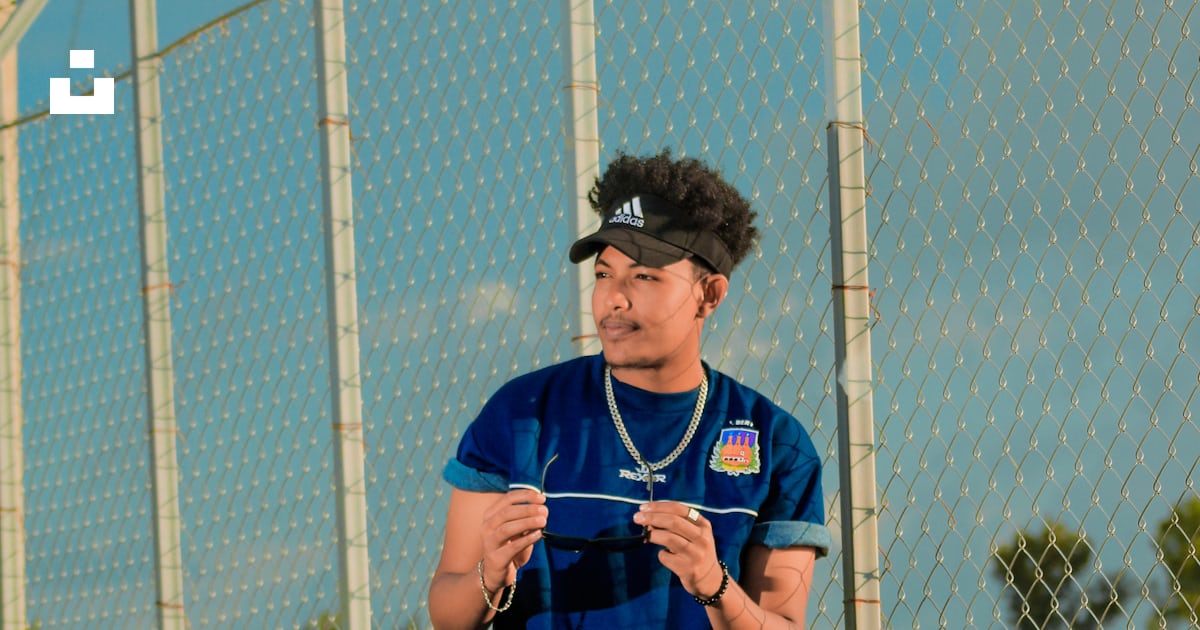 A Man Standing In Front Of A Chain Link Fence Photo Free Ethiopia
