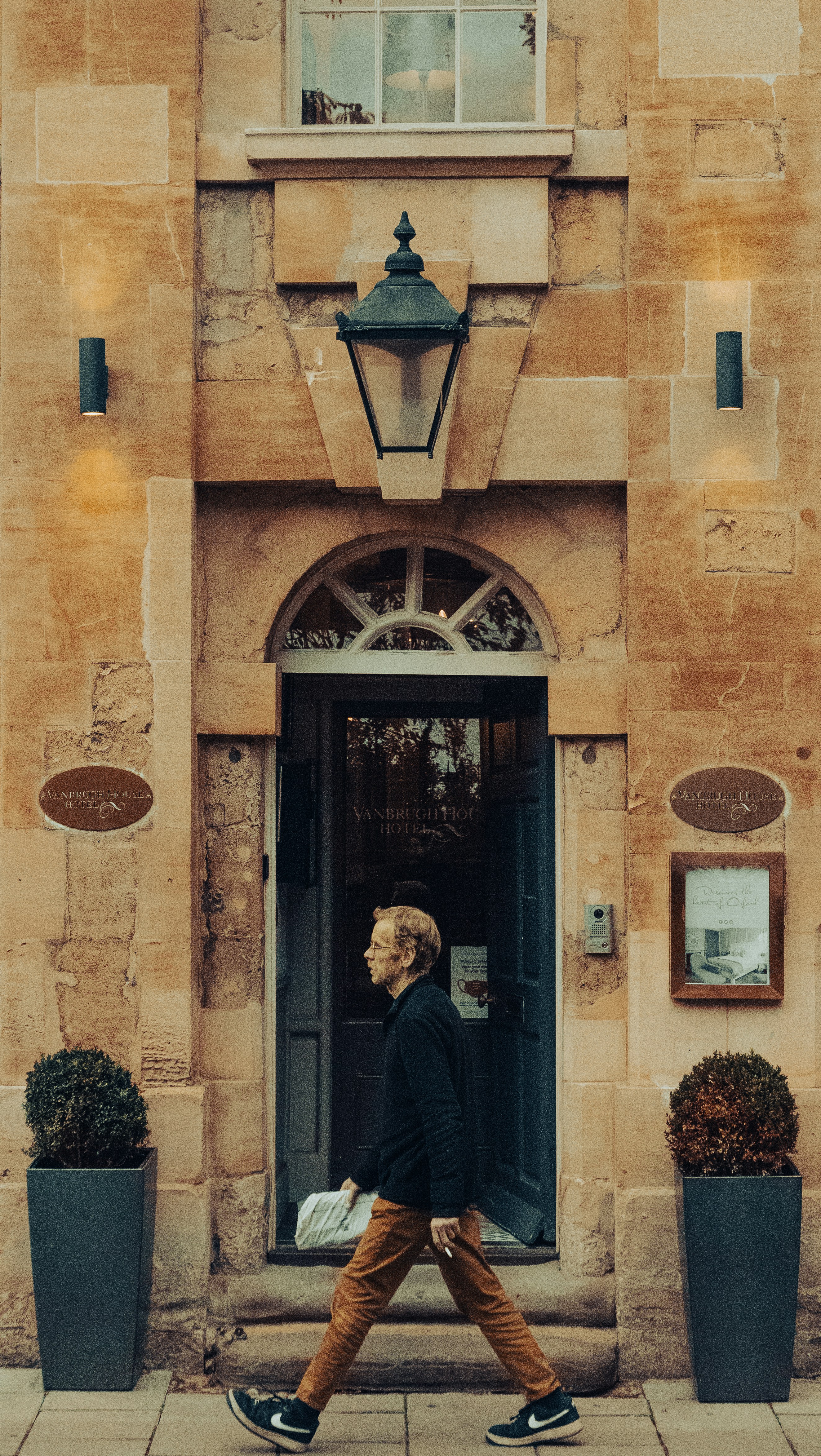 A-street Walk: Portrait of a Man Crossing an Historic Entrance