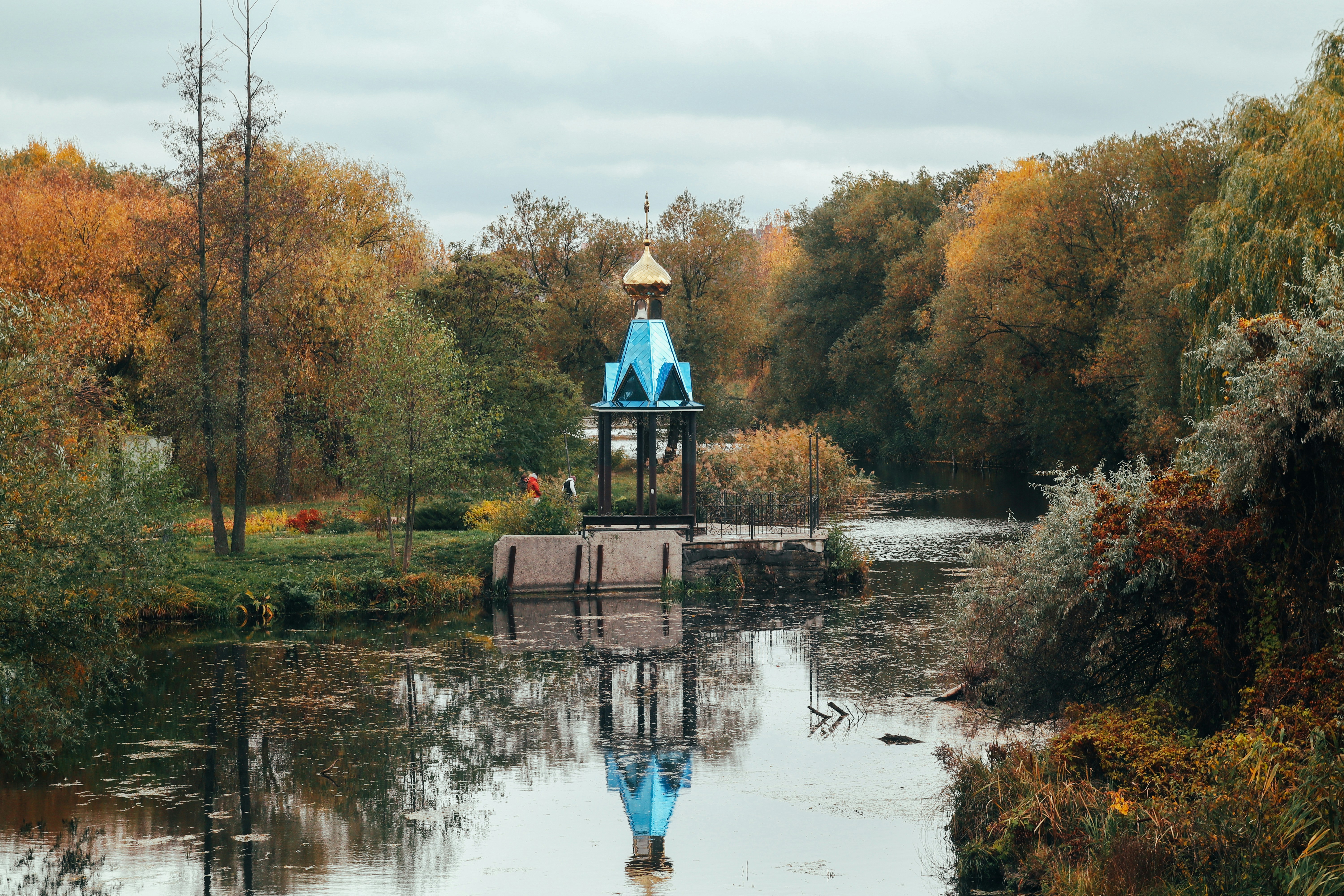 A pond with a clock tower in the middle of it photo – Free Kharkiv ...