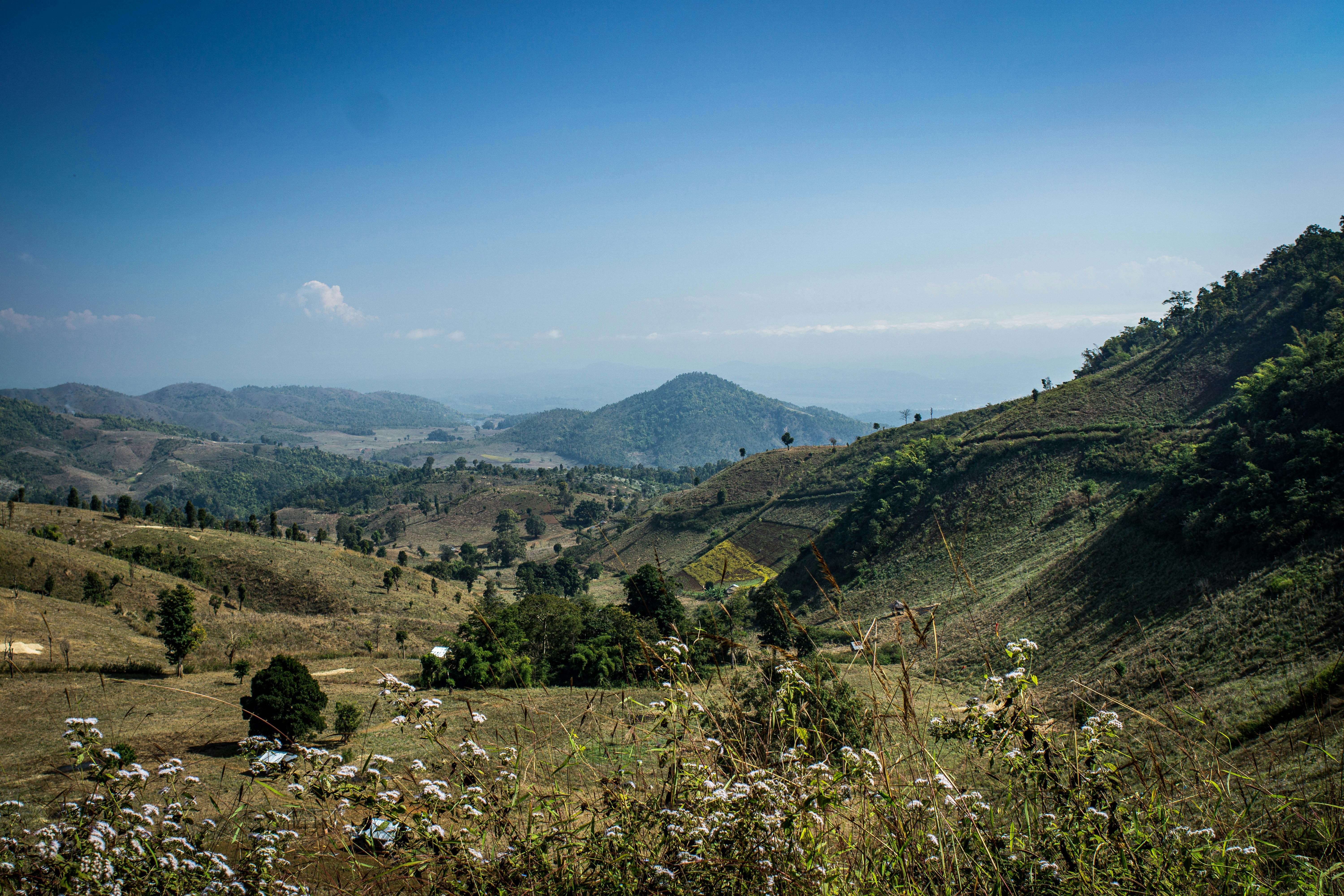 A view of a valley with mountains in the background photo – Free ...