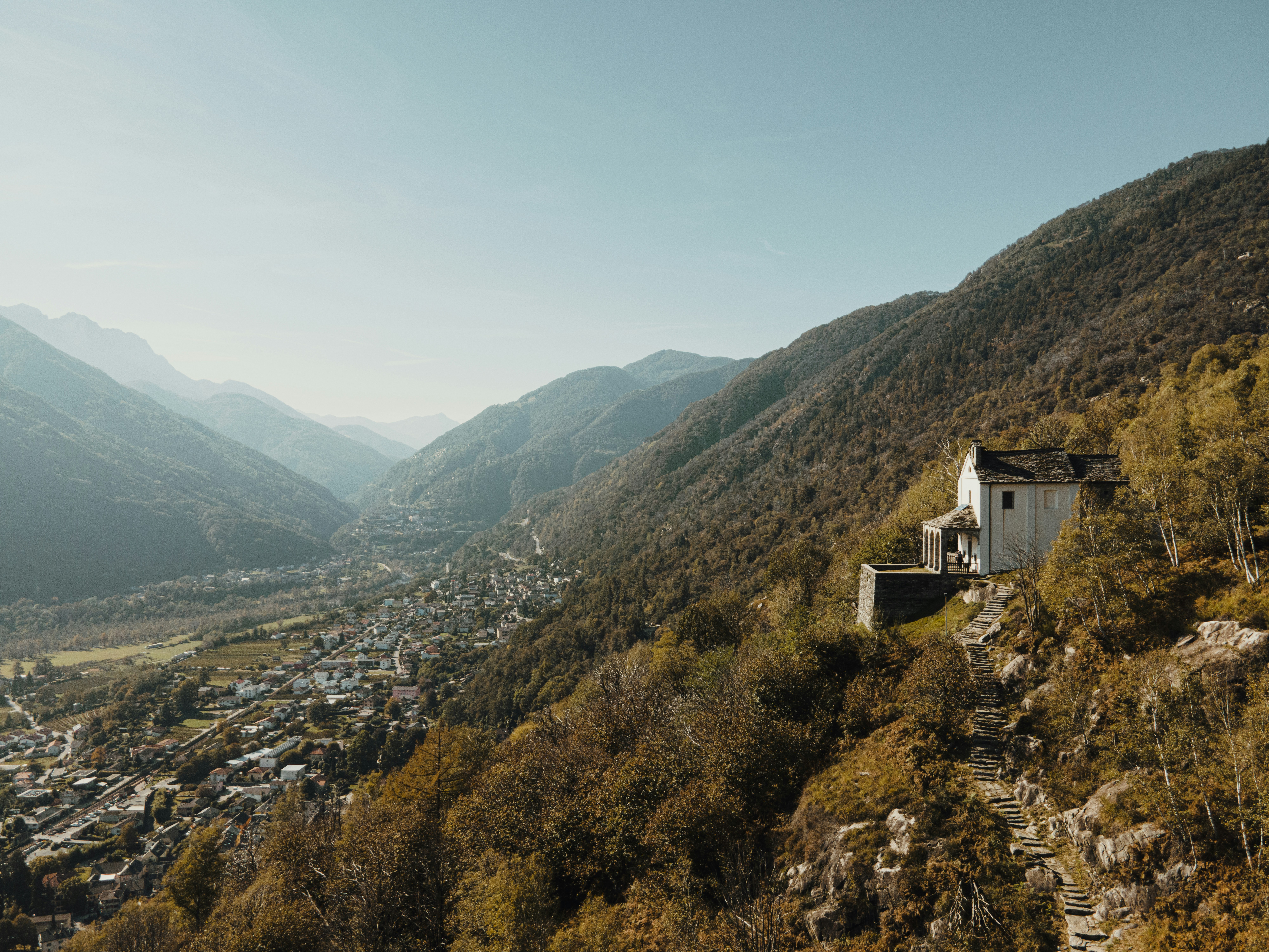 Terraced Cliffhouse Overlooking a Mountain-Valley Town