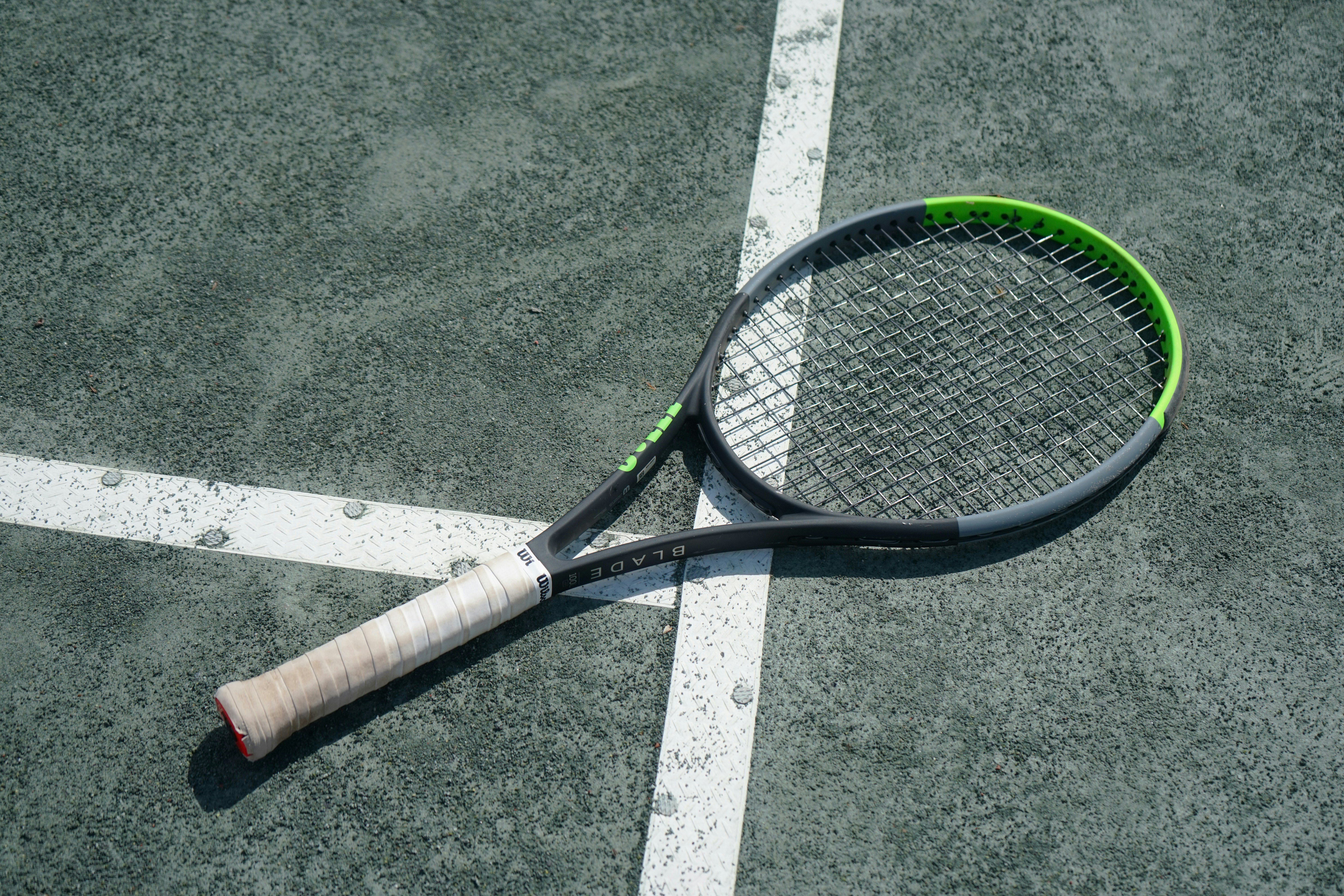 A tennis racket laying on a tennis court photo – Free Williams road ...