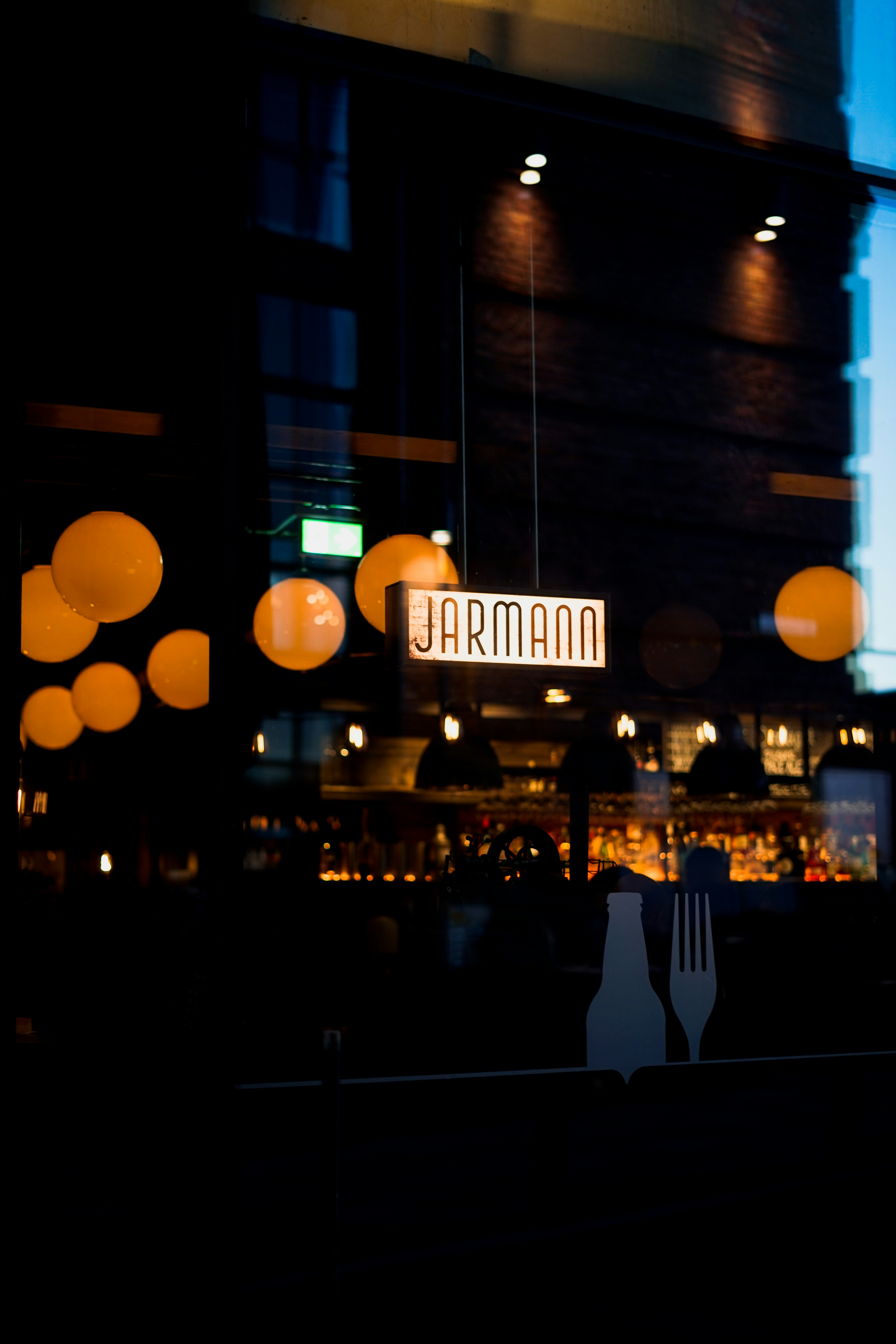 Orange Orbs and Neon Sign: Nightlife Through a Window
