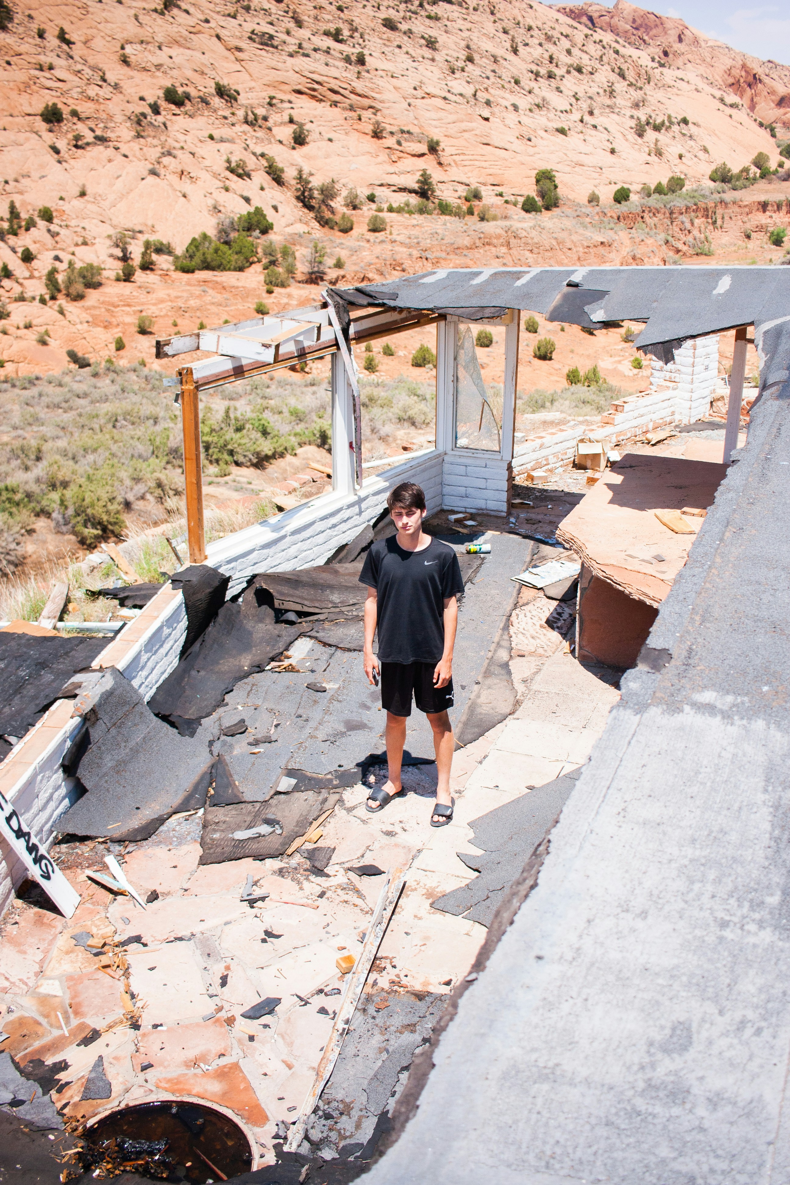 Solitary Figure on a Sun-Bleached Rooftop Amid Desert Ruins