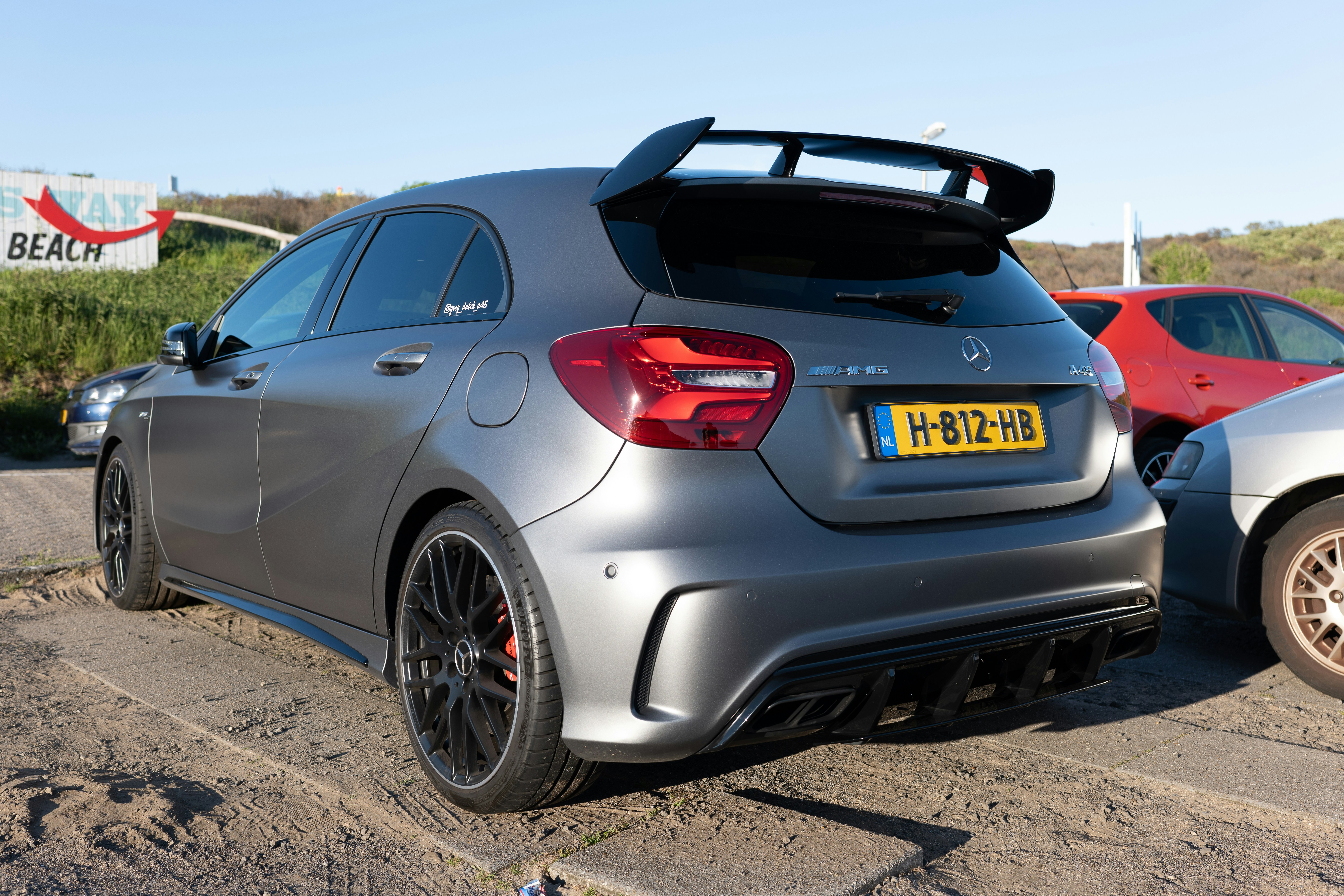 Rear-View Vigor: A Compact AMG Hatch Resting on Gravel