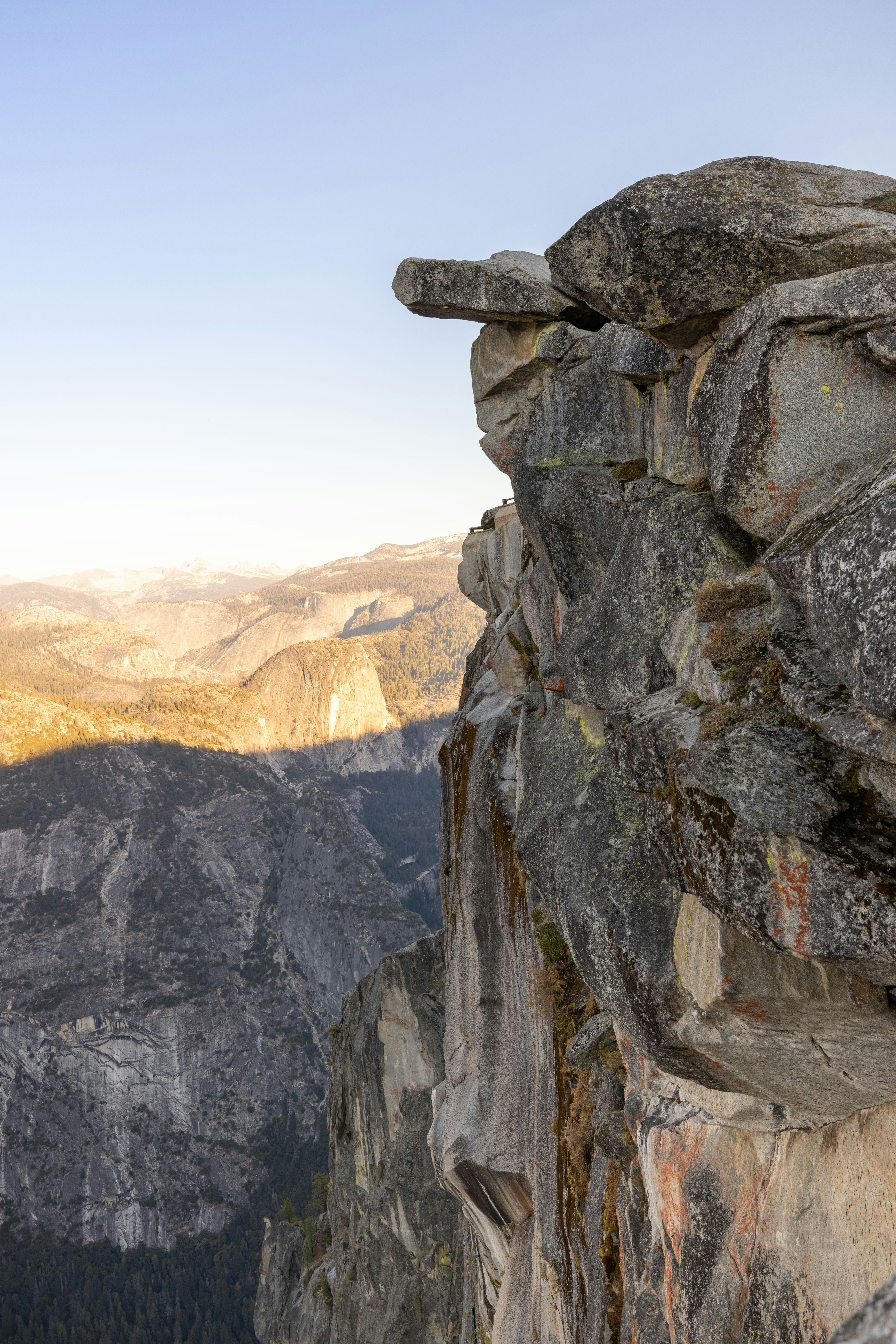Edge of the World: Granite Overhang Above a Sunlit Valley