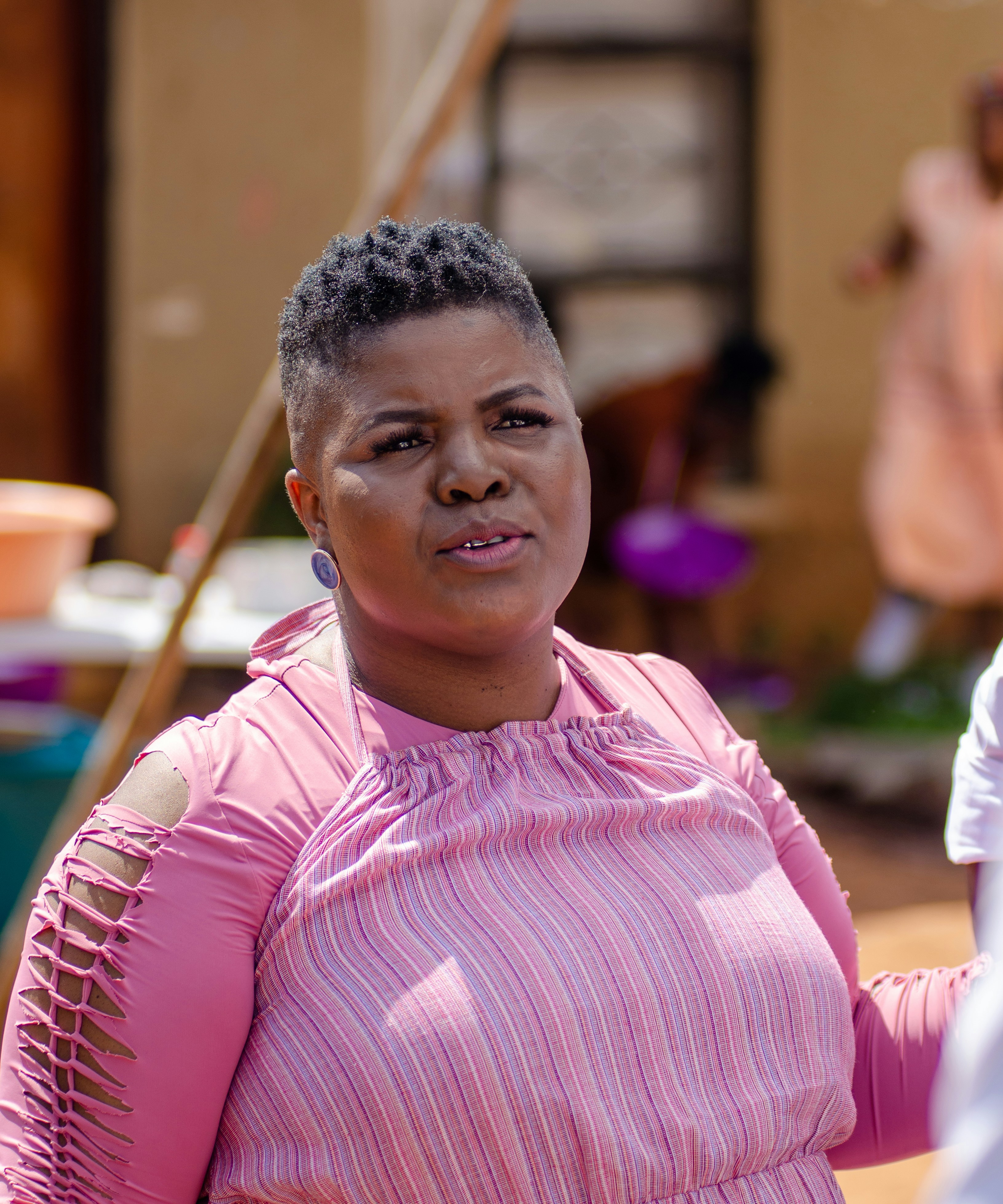 A woman in a pink dress holding a cell phone photo – Free Winne mandela ...