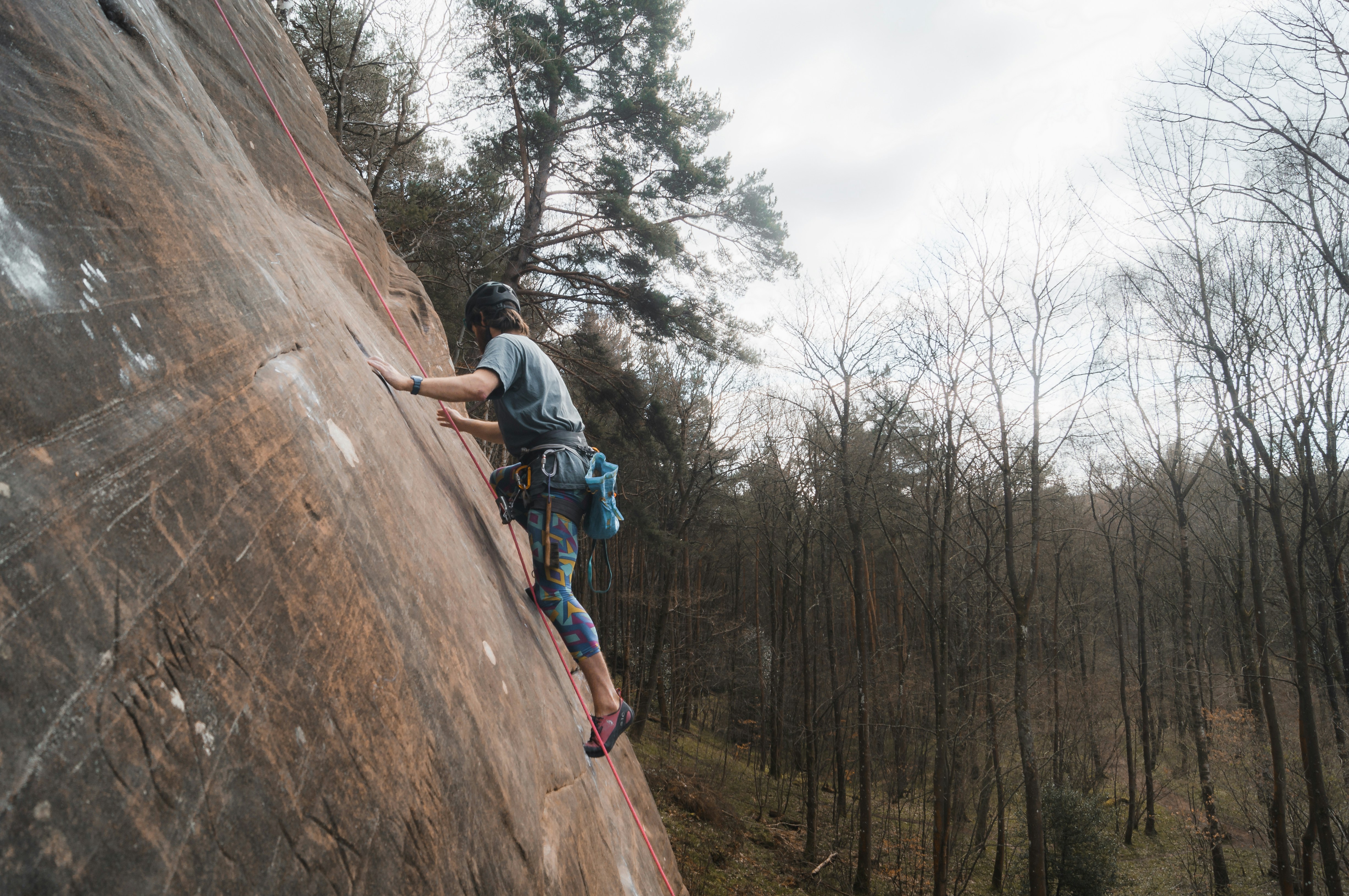 A man climbing up the side of a mountain photo – Free Armathwaite Image ...