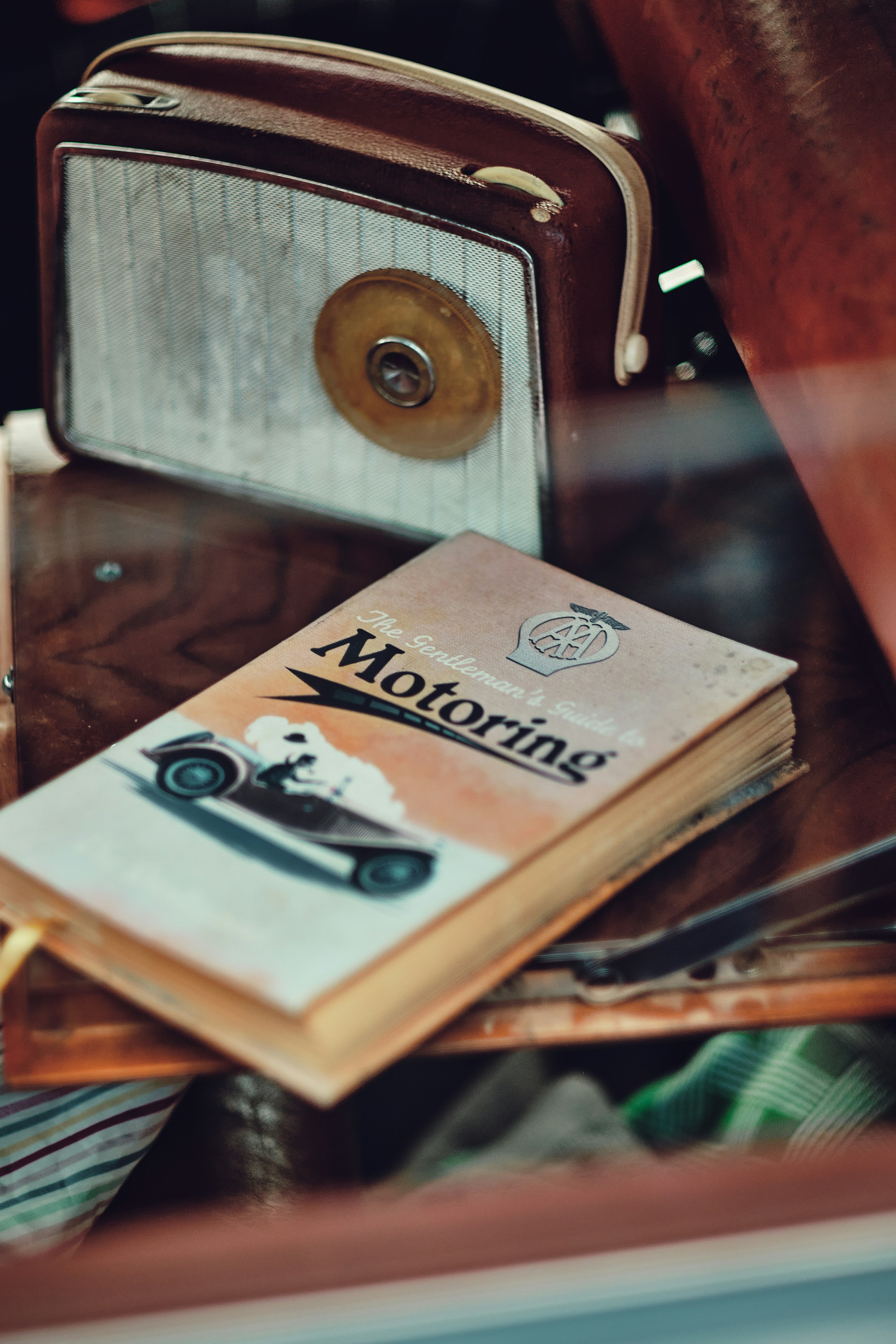 Dial in the Dust: A Vintage Radio Set Beside a Motoring Magazine
