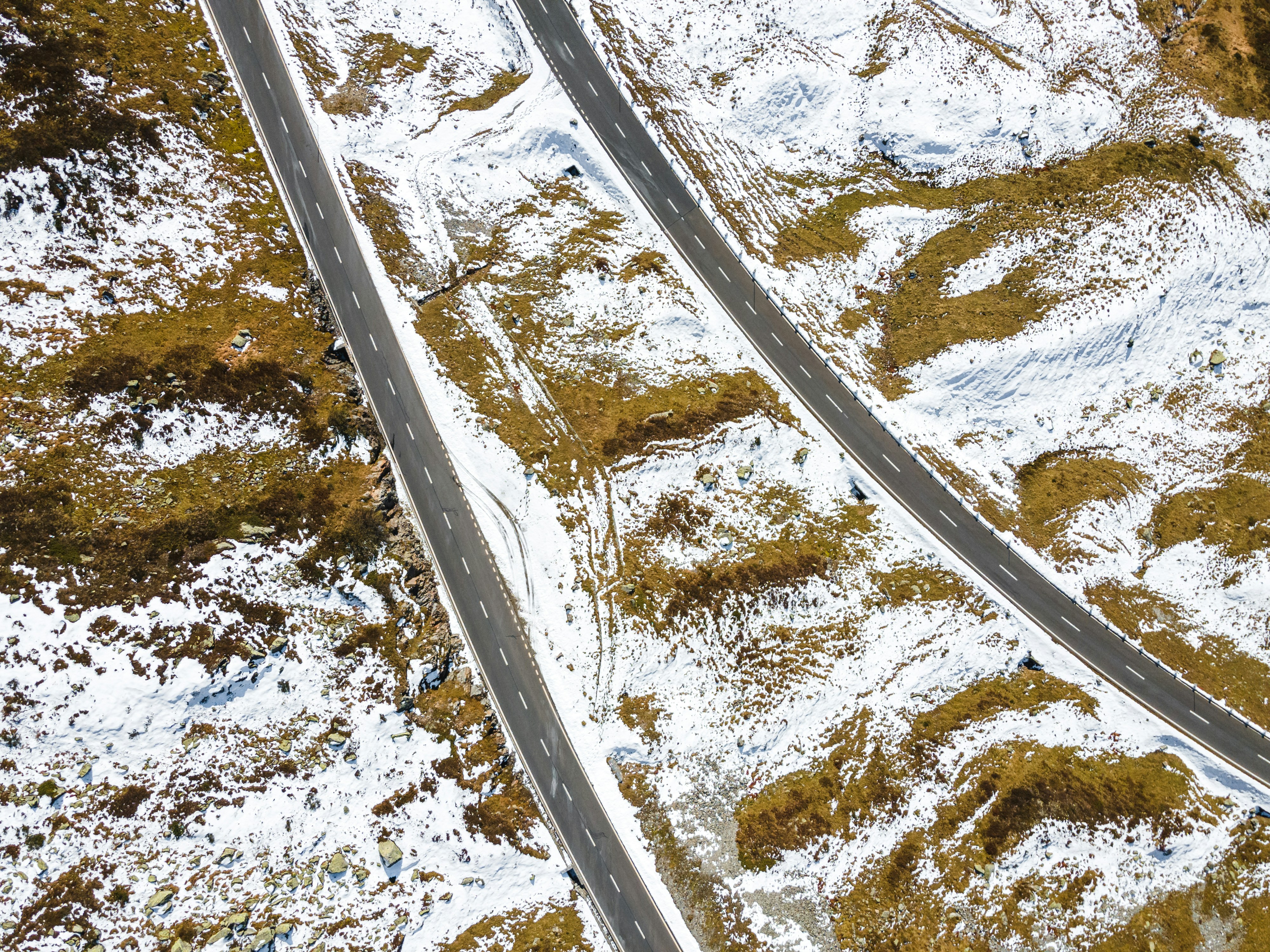 Snow-lined Roadway: Aerial S-curve Through Frosted Terrain