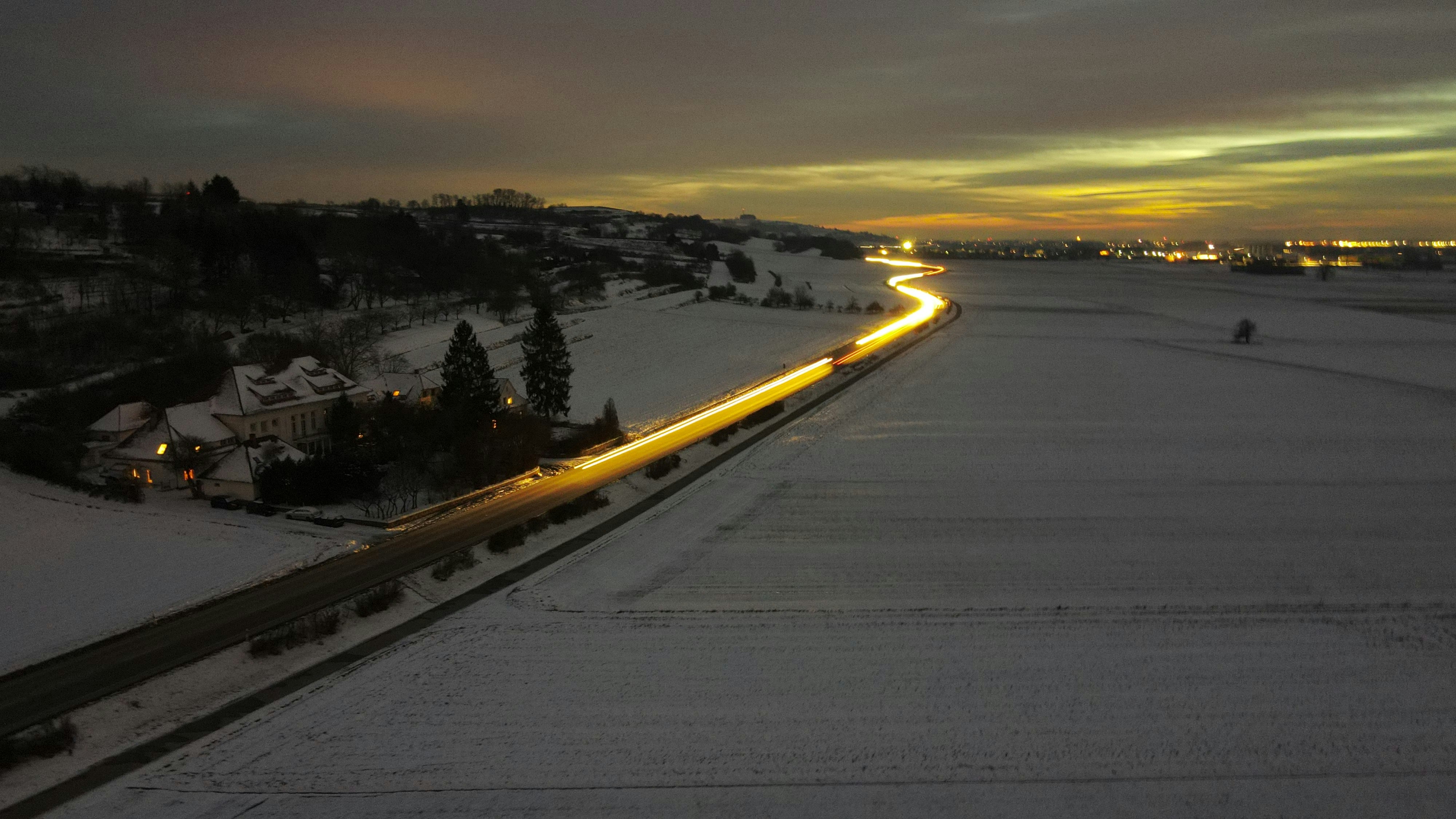 Golden Ribbon Over Snow: A Distant Winter Horizon