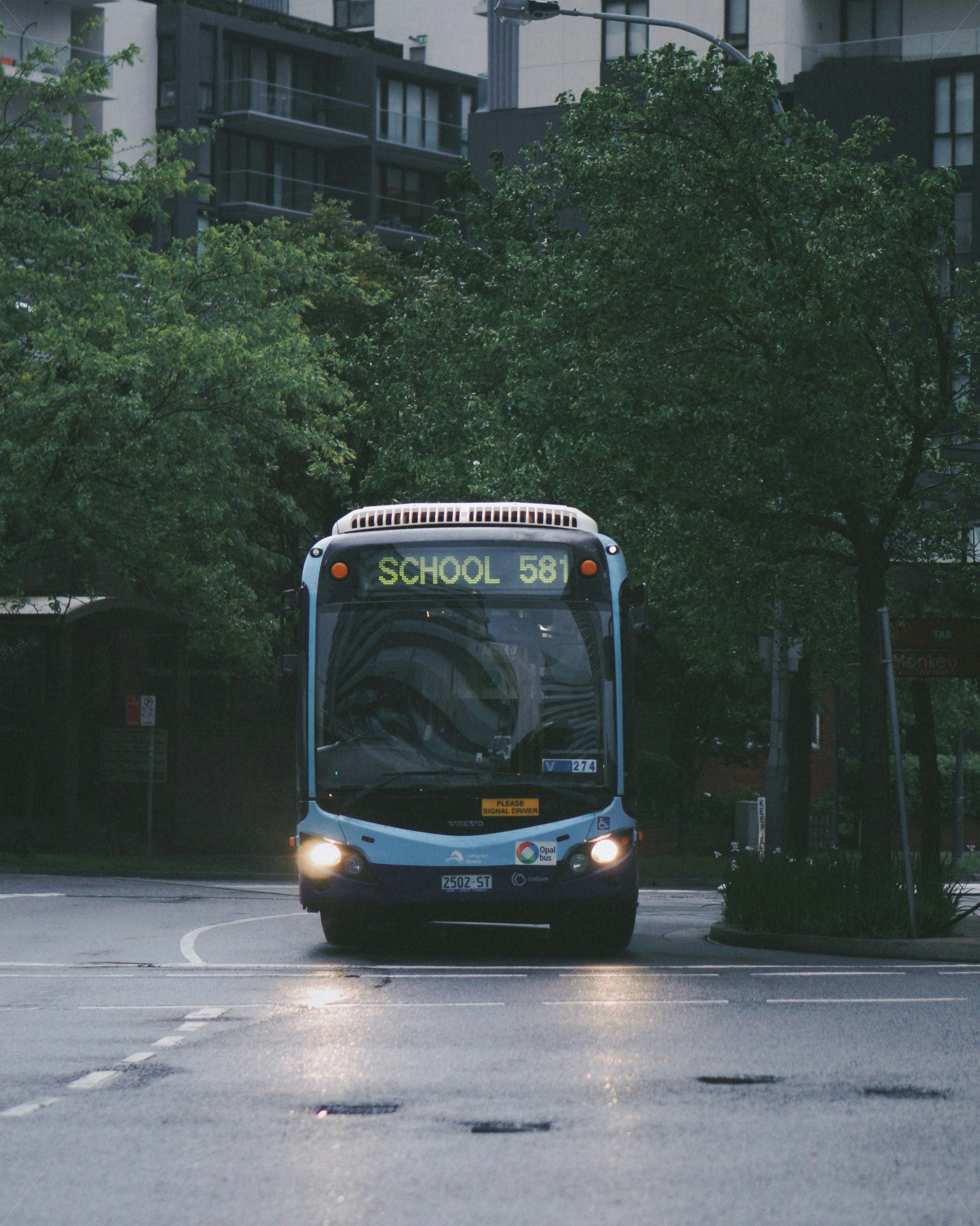 Oncoming City Bus: The School Run in Wet Evening Light
