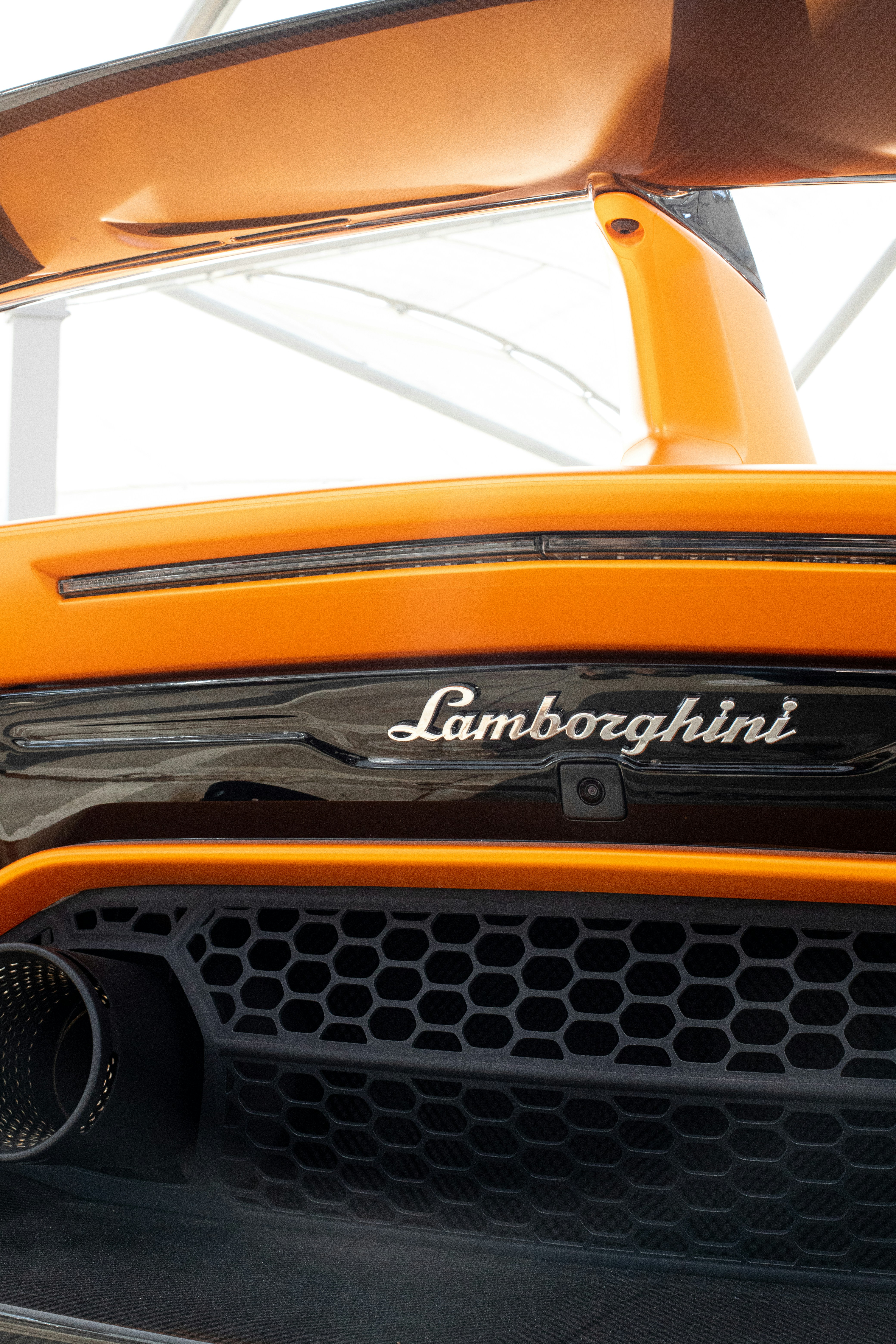 a close up of the front of an orange sports car