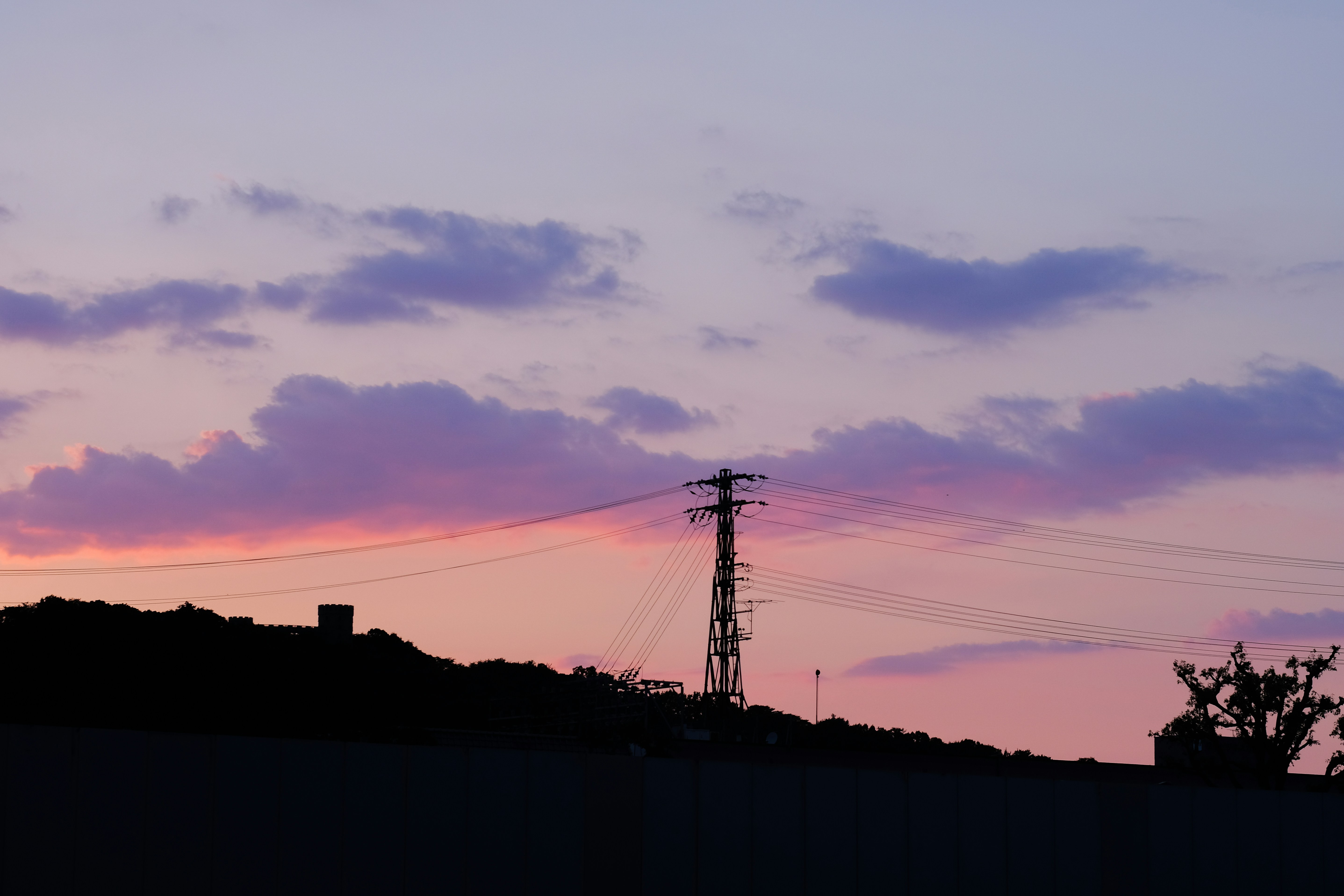 Twilight Grid: Silhouette of a Tower Against a Pink-Blue Dusk