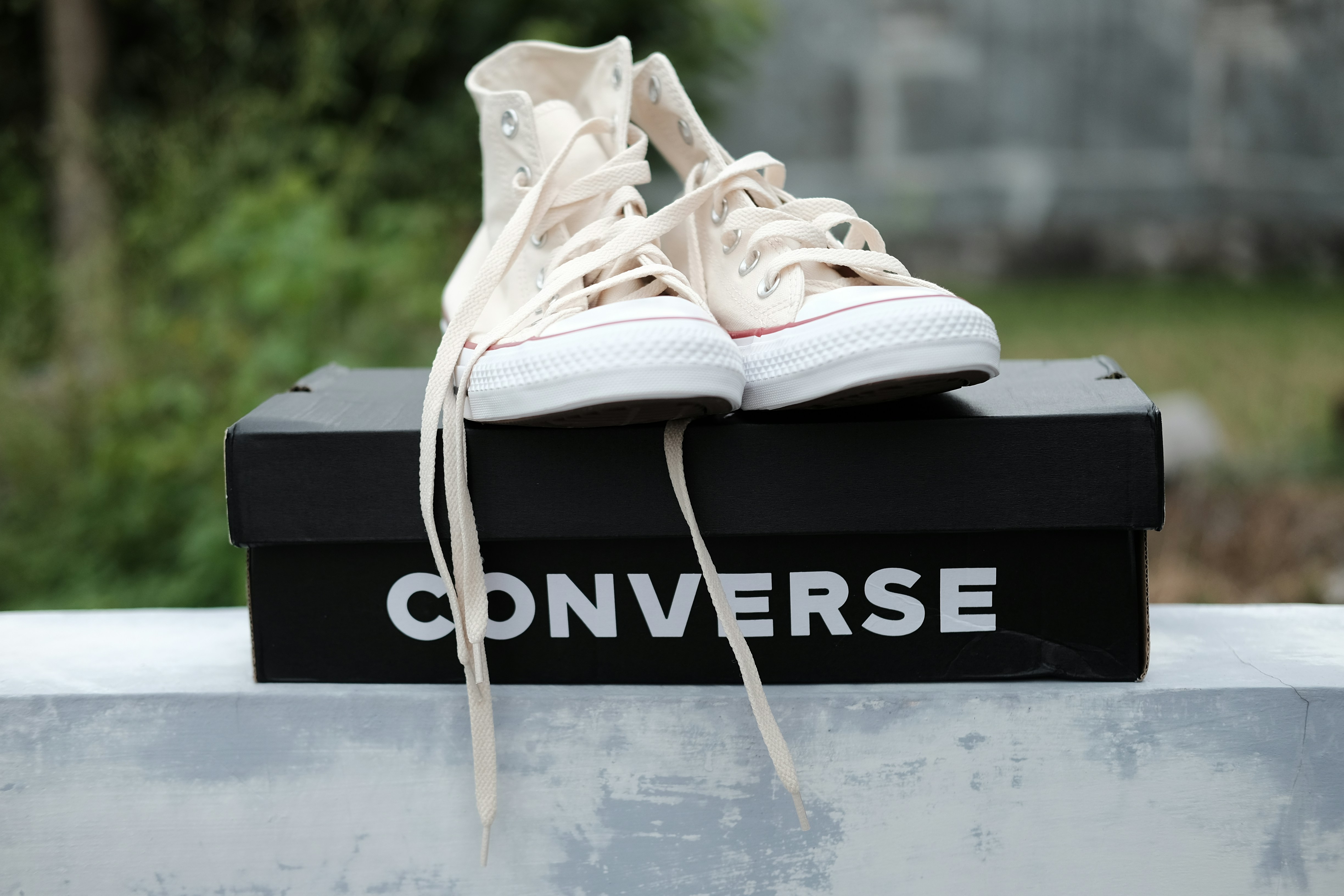 Classic Converse sneakers resting on their signature box, showcasing a blend of nostalgia and contemporary design.