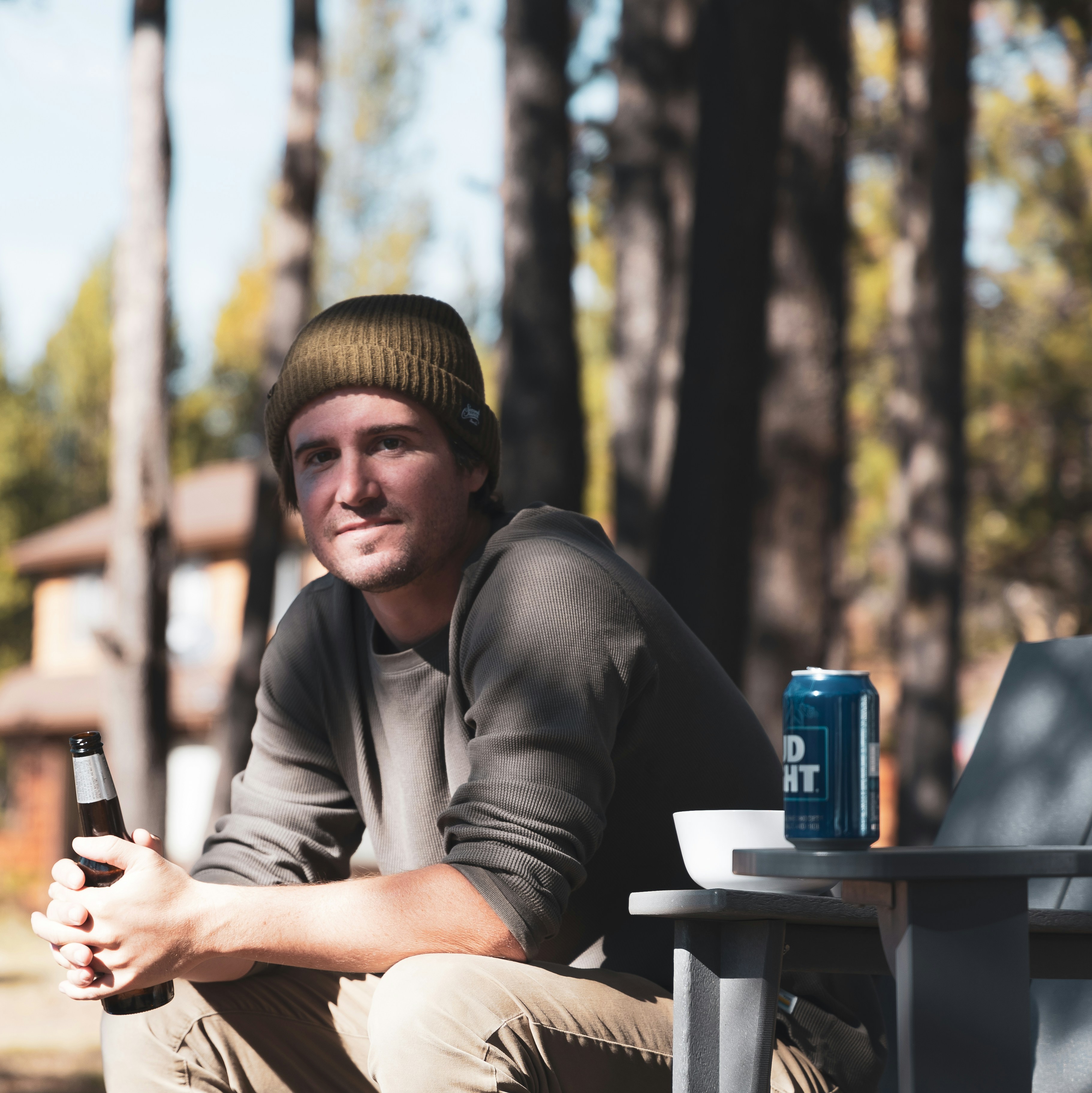 a man sitting at a table with a beer