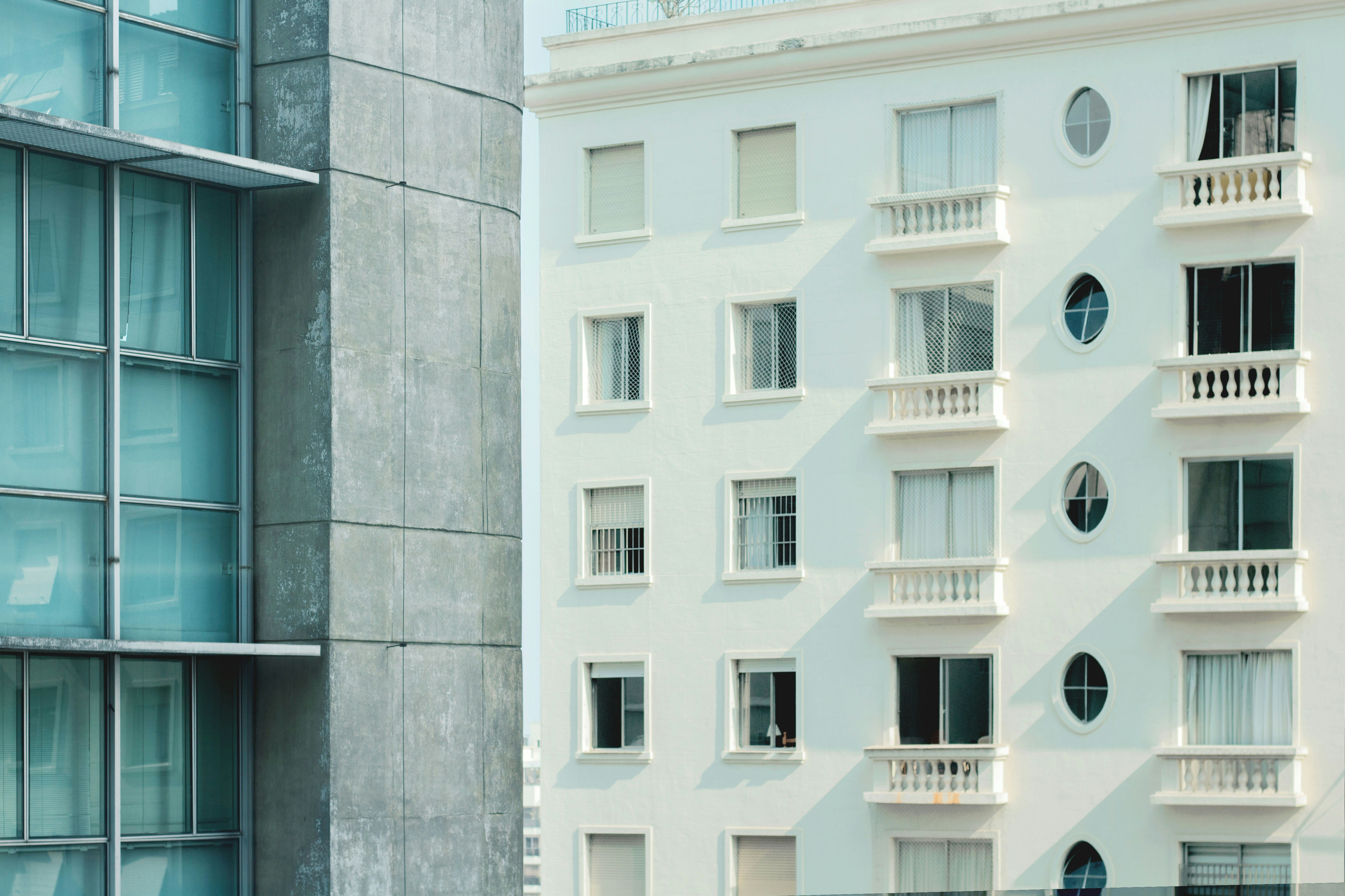 A tall white building with balconies and windows photo – Free Classic ...