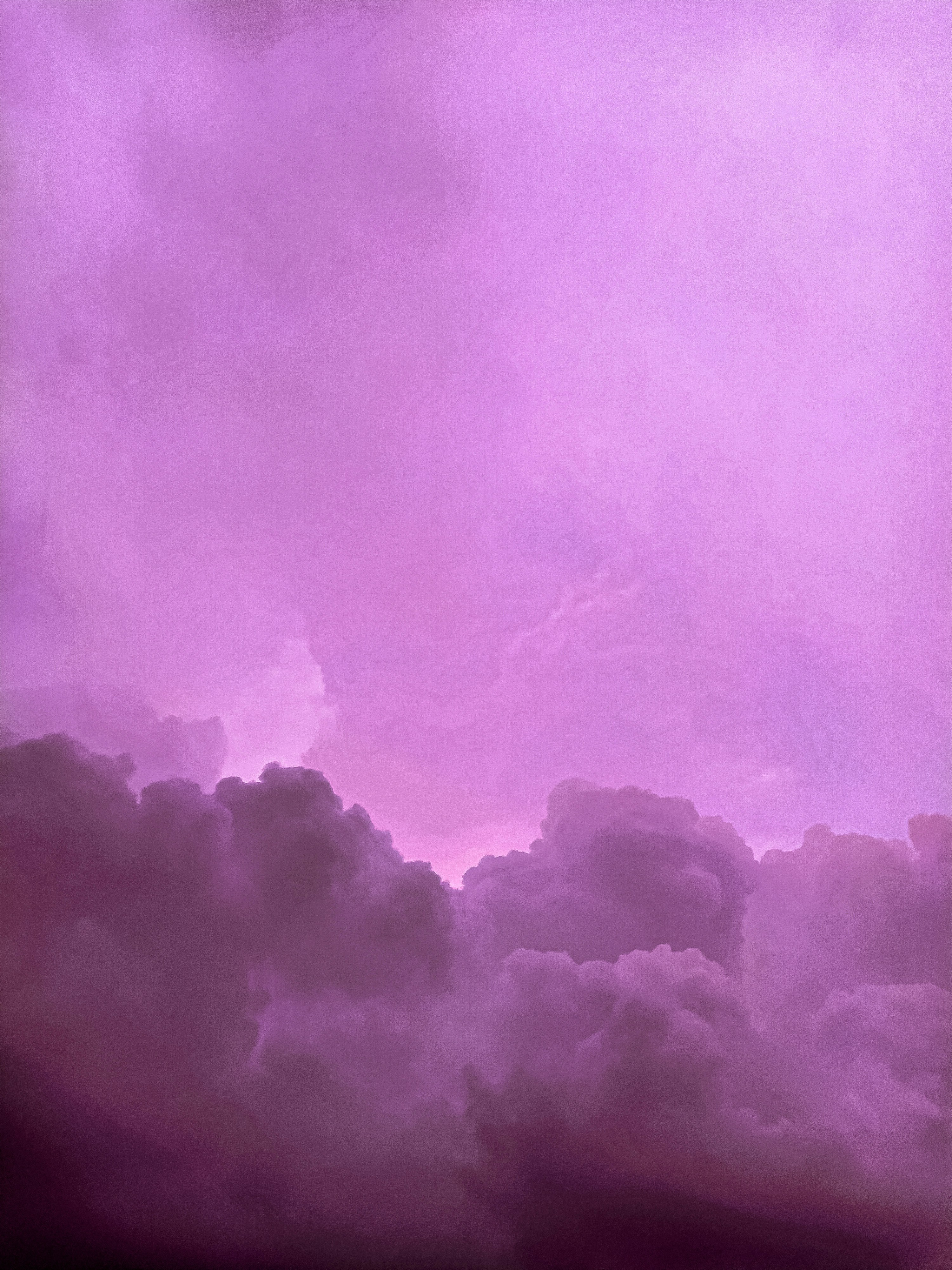 Purple hued clouds create a dreamy, surreal sky.