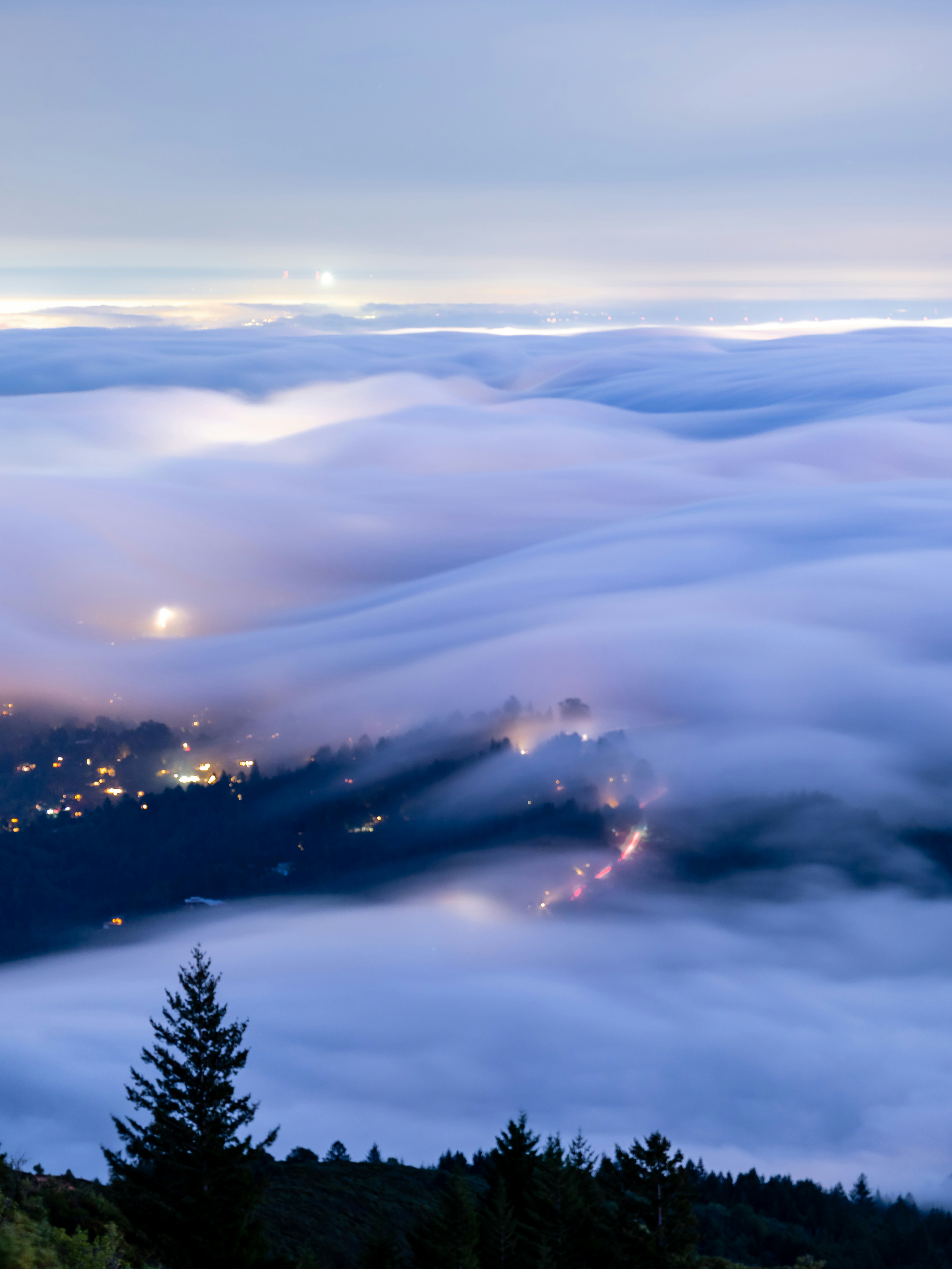 This happens during the summer. As the valleys begin to cool off around 3-4 PM, the cold Pacific air gets drawn to the interior. Seas and rivers of fog cascade down the Coast Range North and South of San Francisco.
