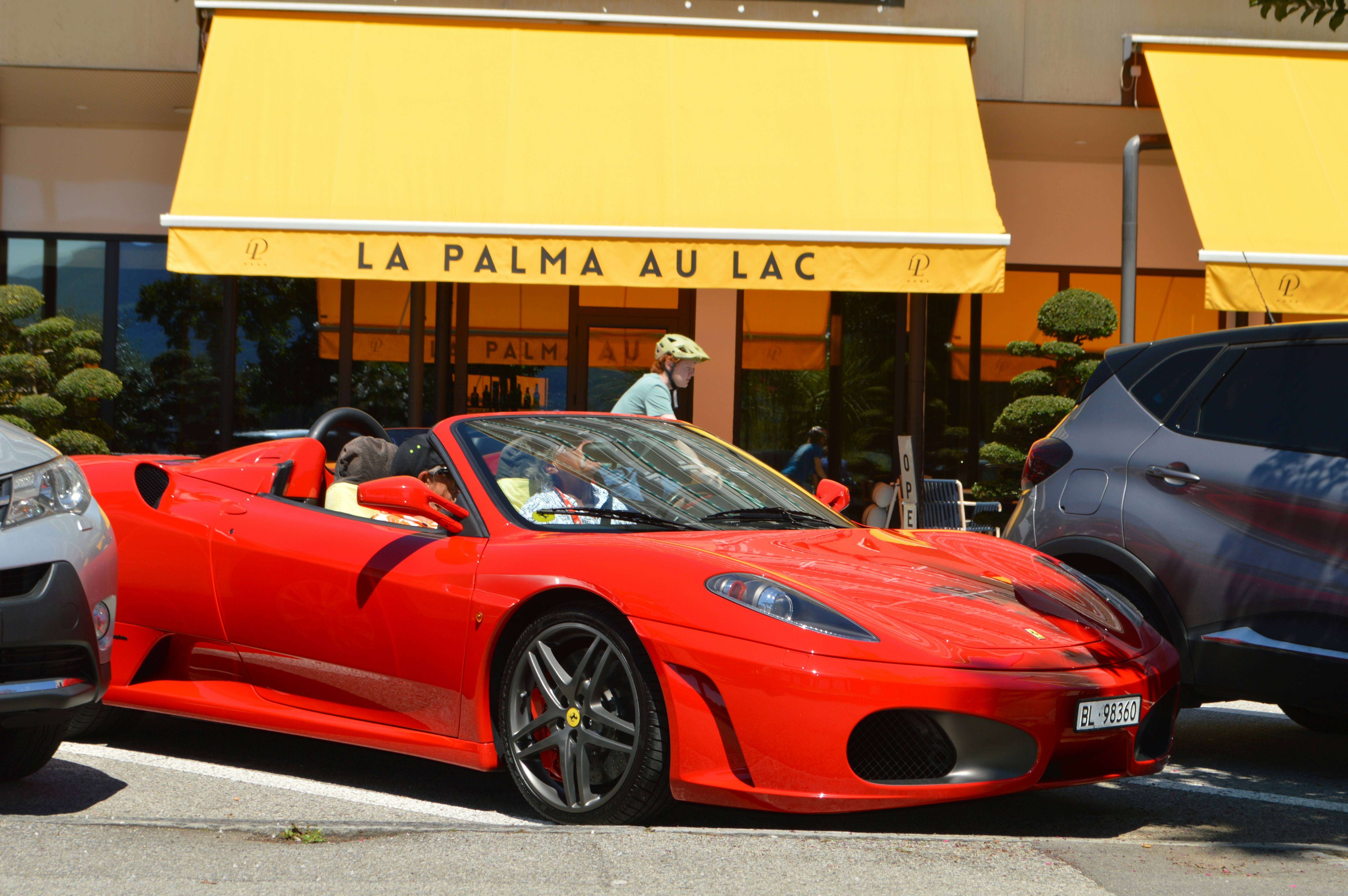 A red sports car parked in front of a building photo – Free Lucano ...