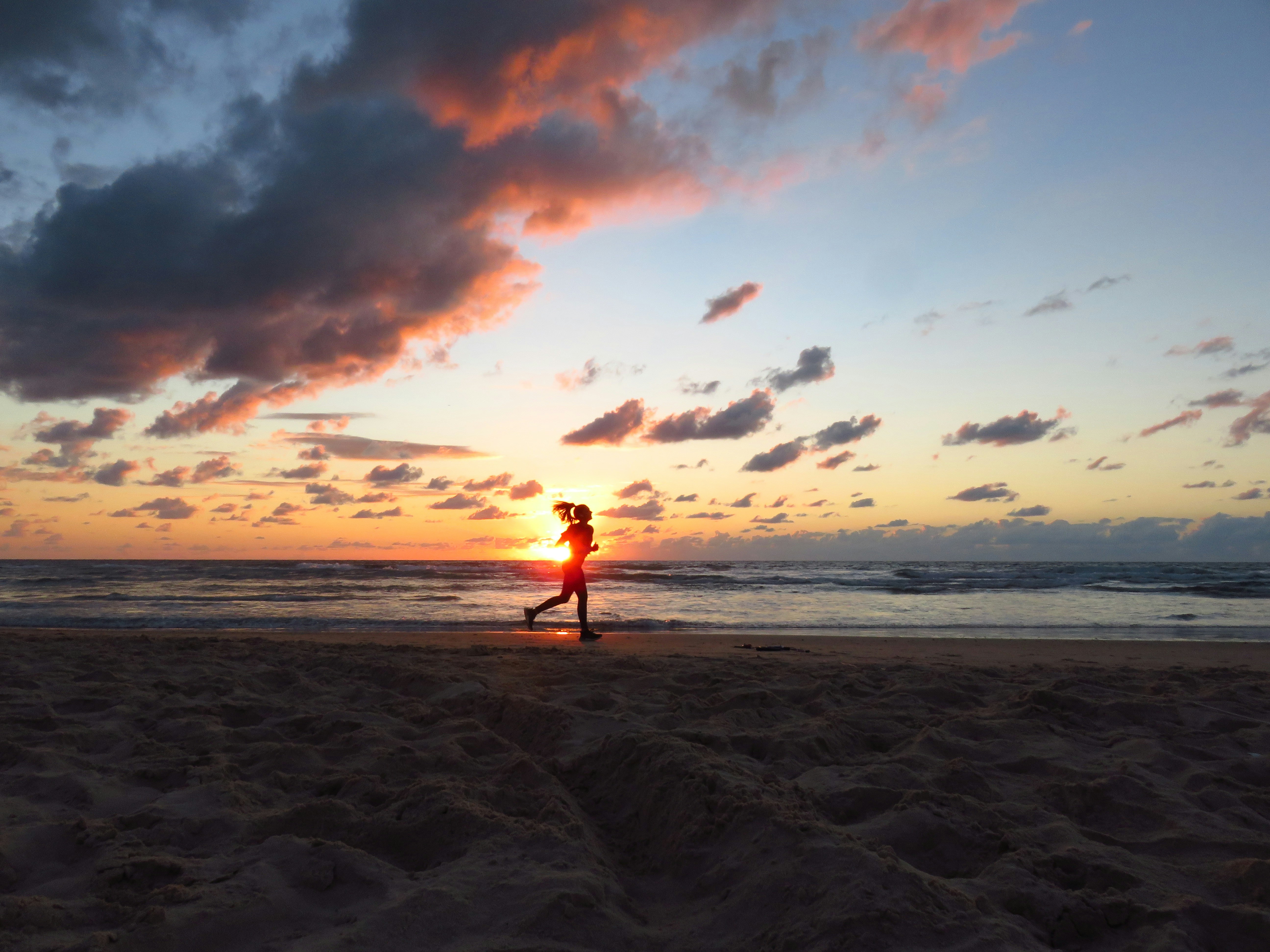 Silhouette Runner at Sunset Over a Quiet Seaside