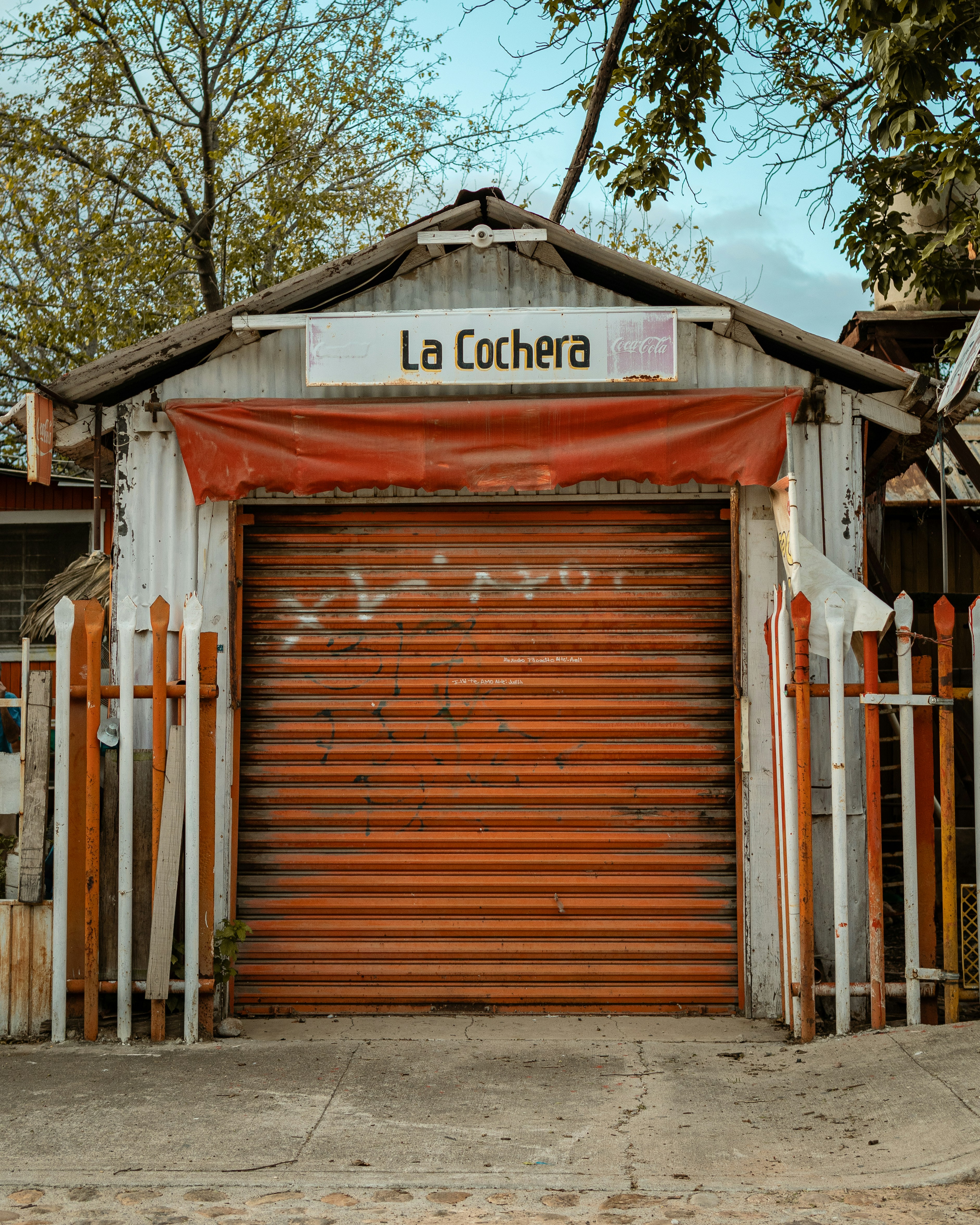 a closed garage with a red awning