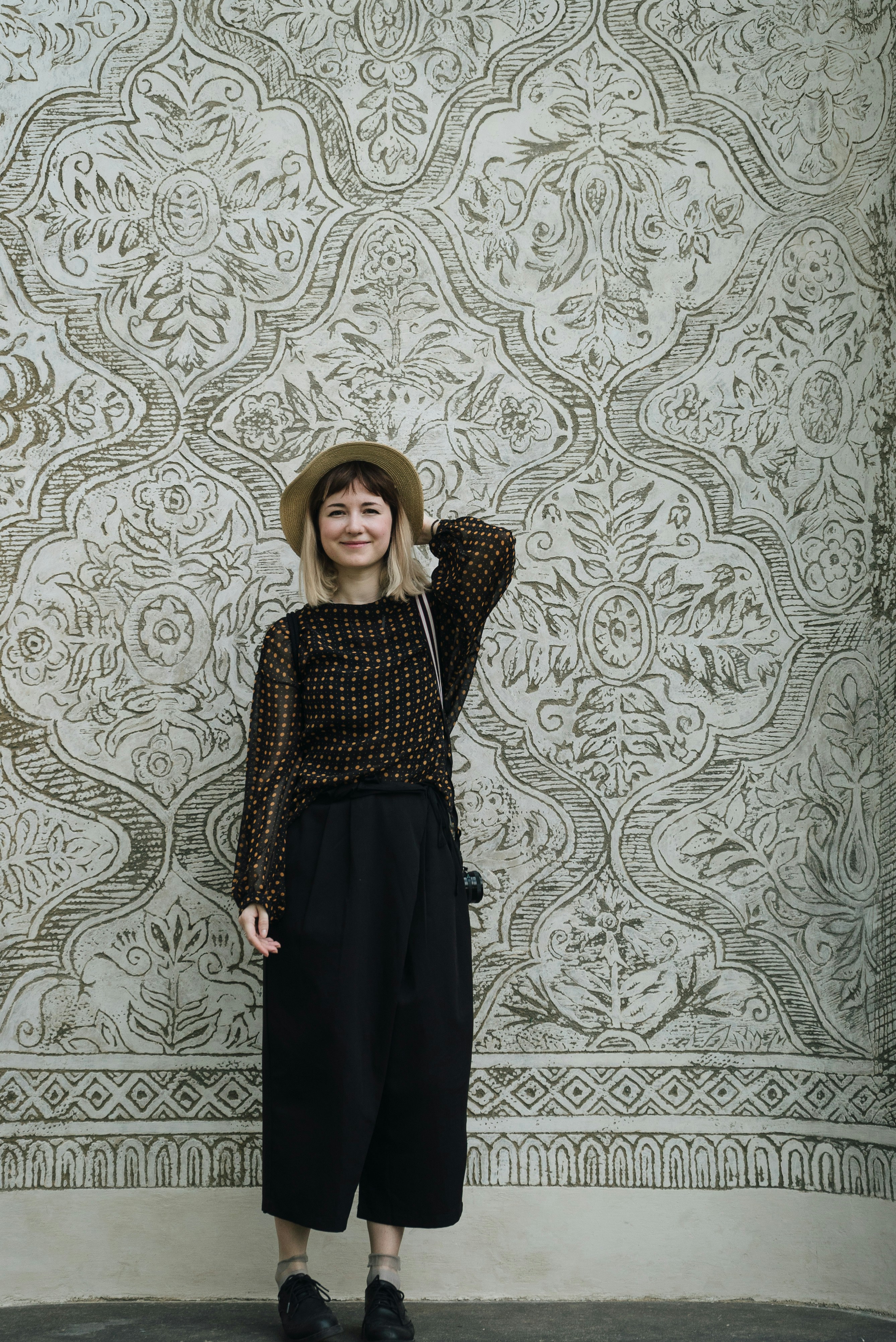 Portrait in Black Mesh Before an Elaborate Ornamental Wall