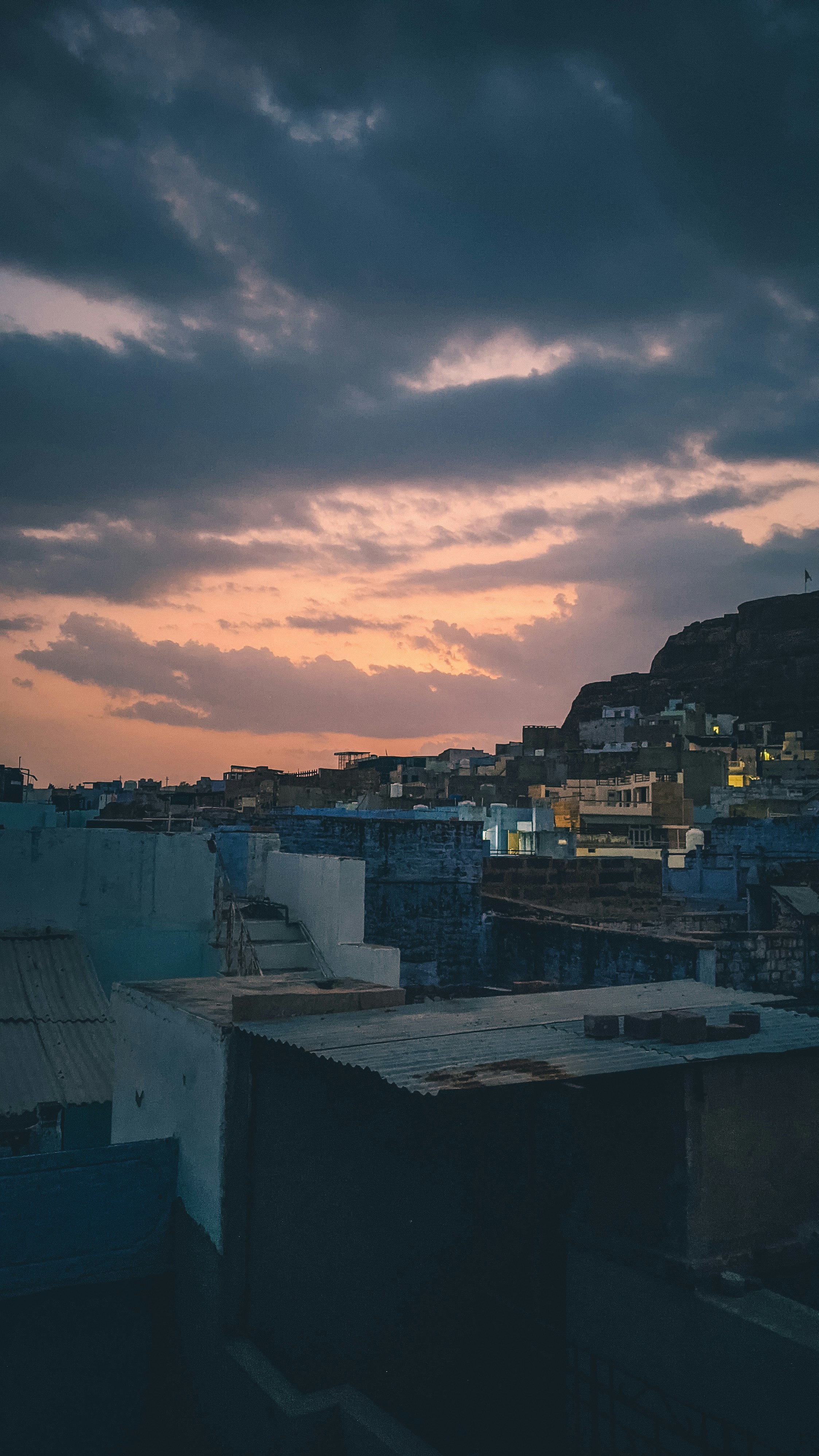 A view of a city from a rooftop at sunset photo – Free Sunset Image on ...