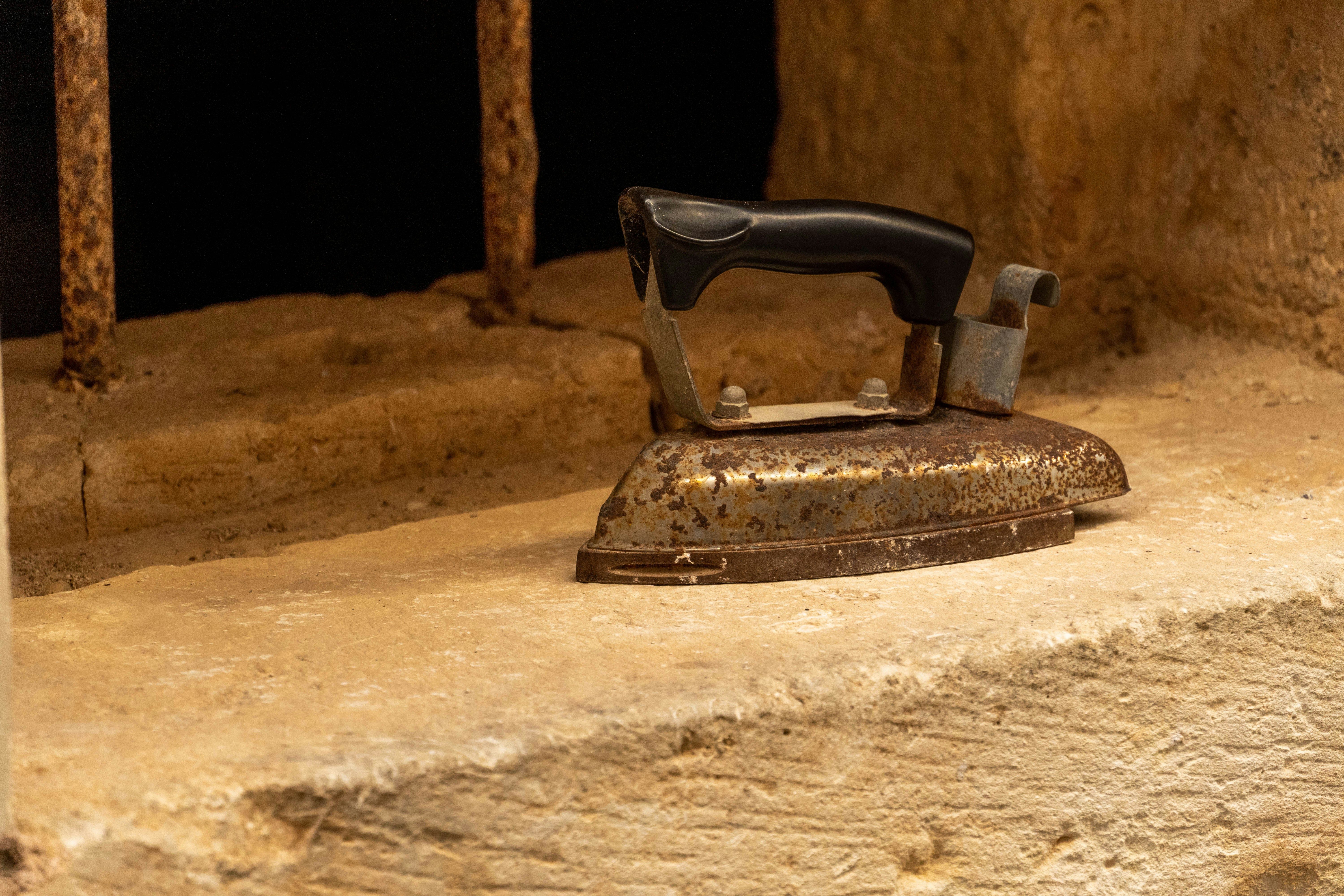 a iron sitting on top of a stone slab