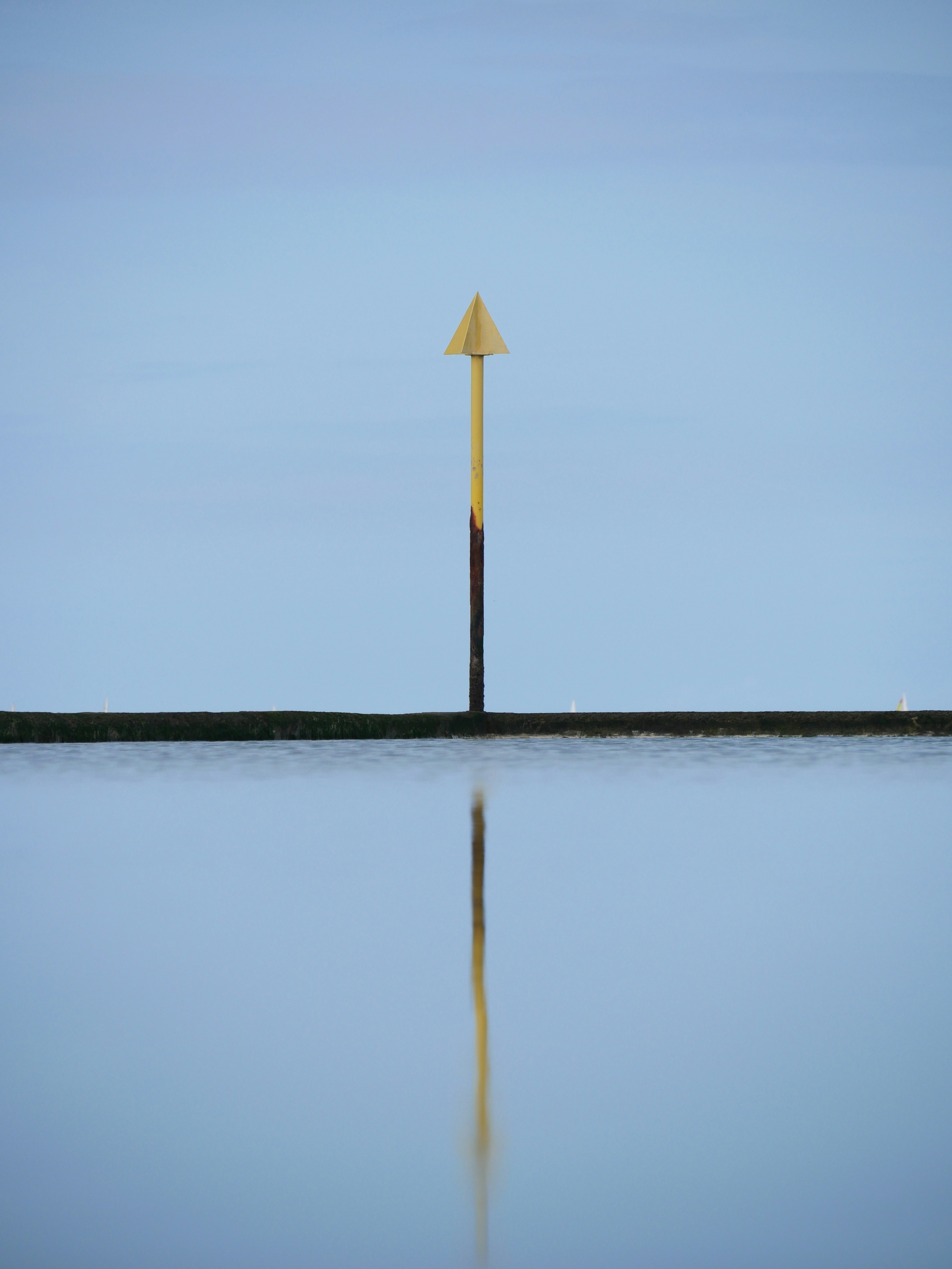 a pole in the middle of a body of water