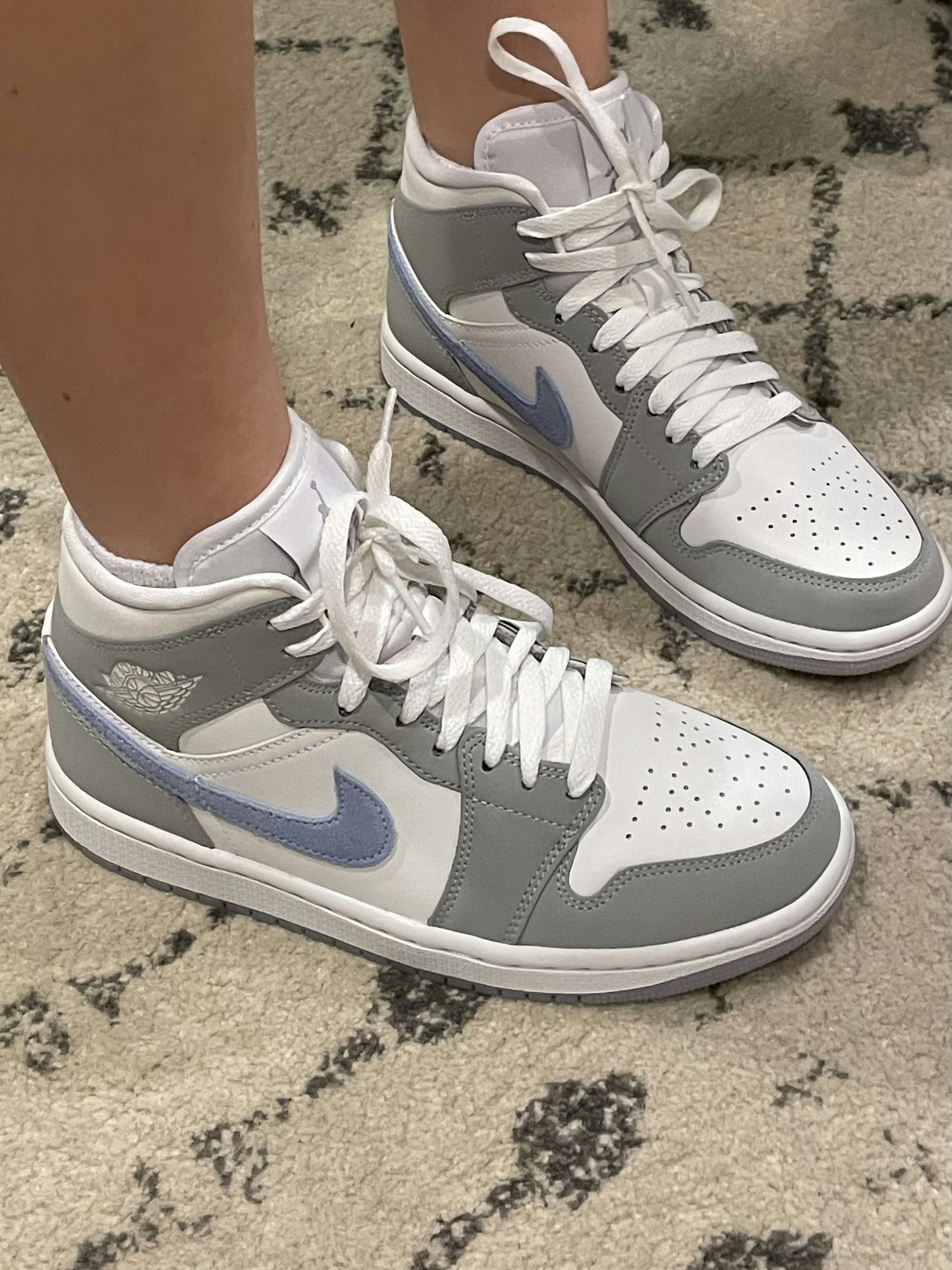 Pastel-Accent Air Jordan 1s Rest on a Plush Rug