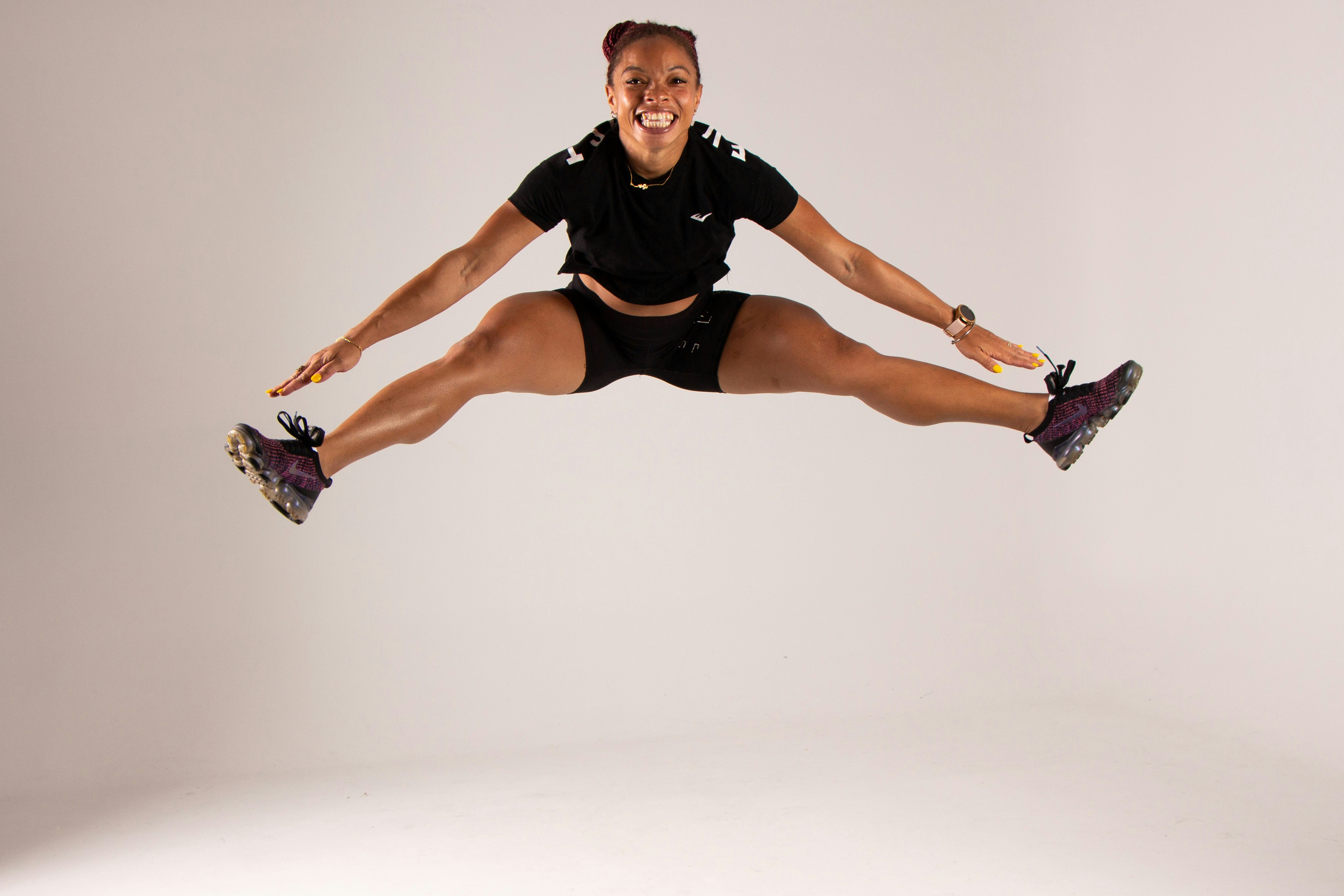 A woman in black shirt and shorts jumping in the air photo – Free Human ...