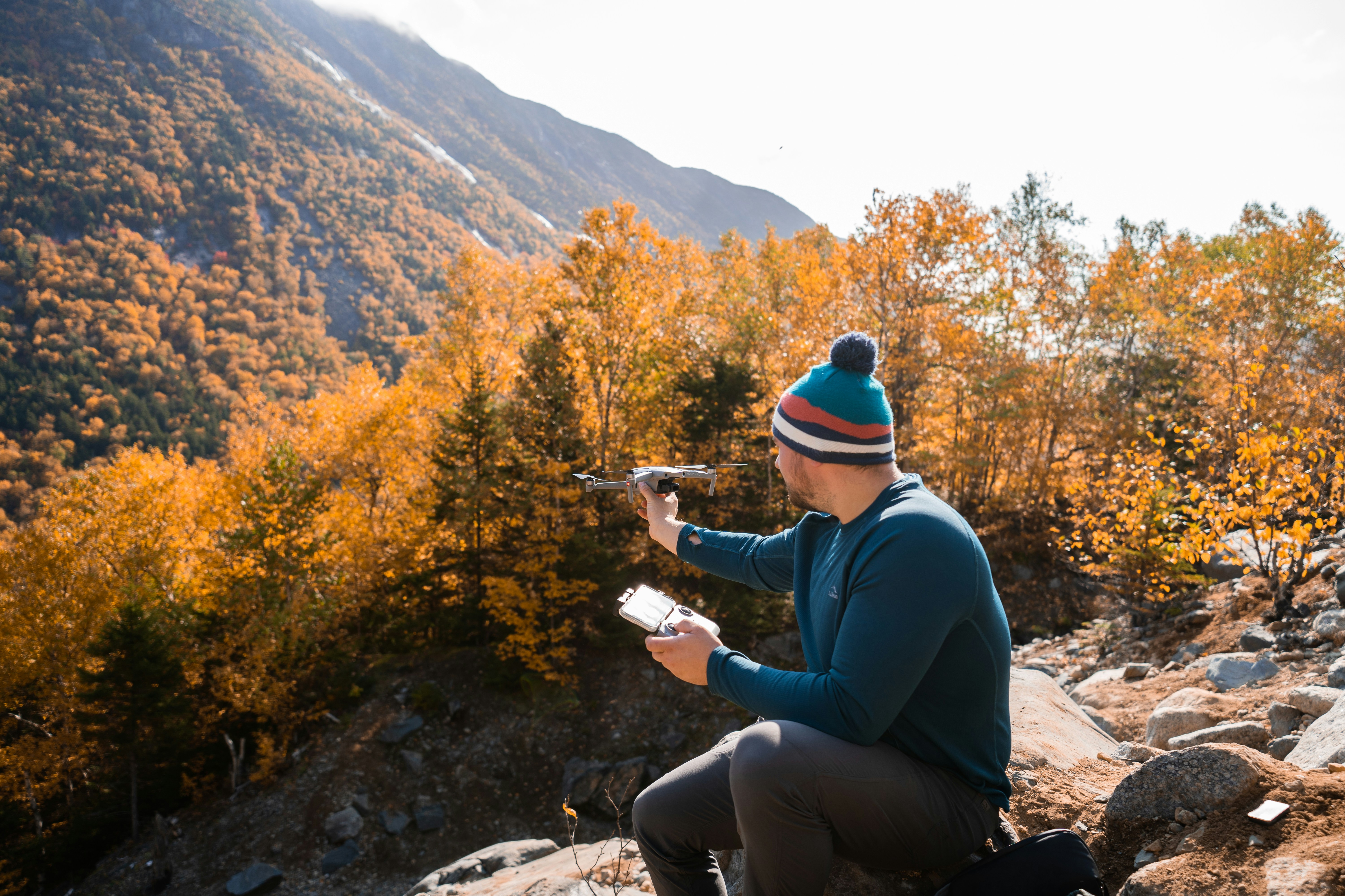 Autumn Summit: A Lone Photographer Among Golden Pines