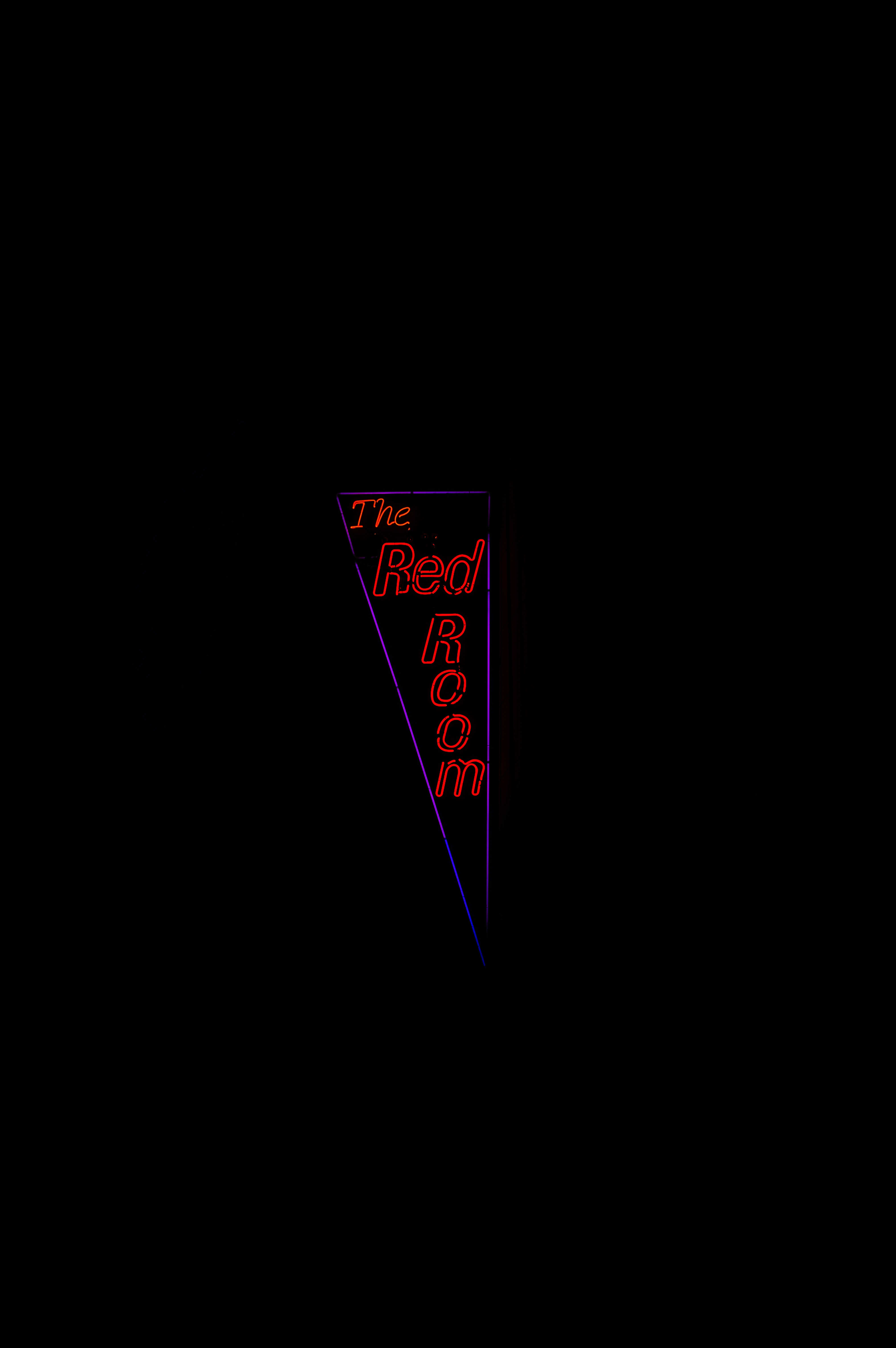 Crimson Neon Triangle: The Red Room Sign in the Dark