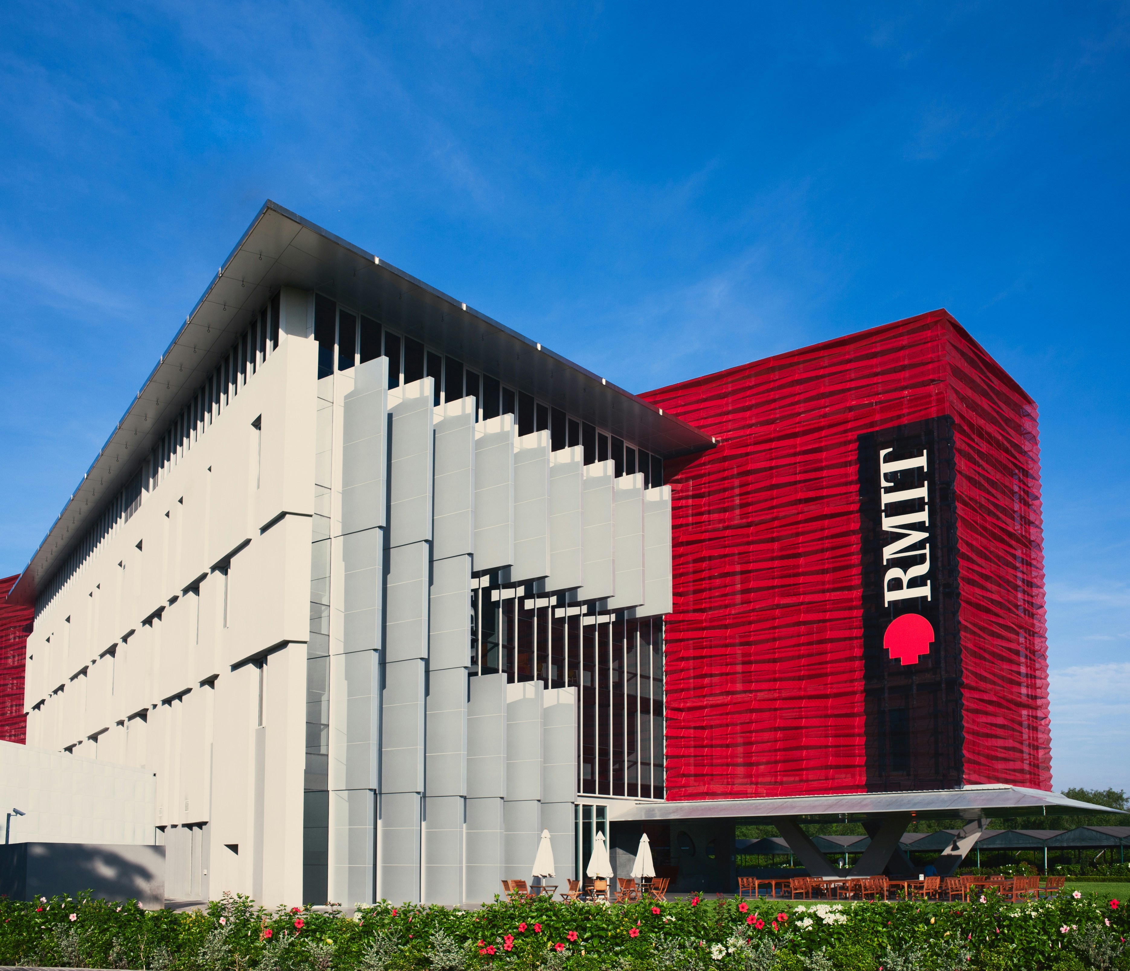 A large building with a red and white facade photo – Free Rmit saigon ...