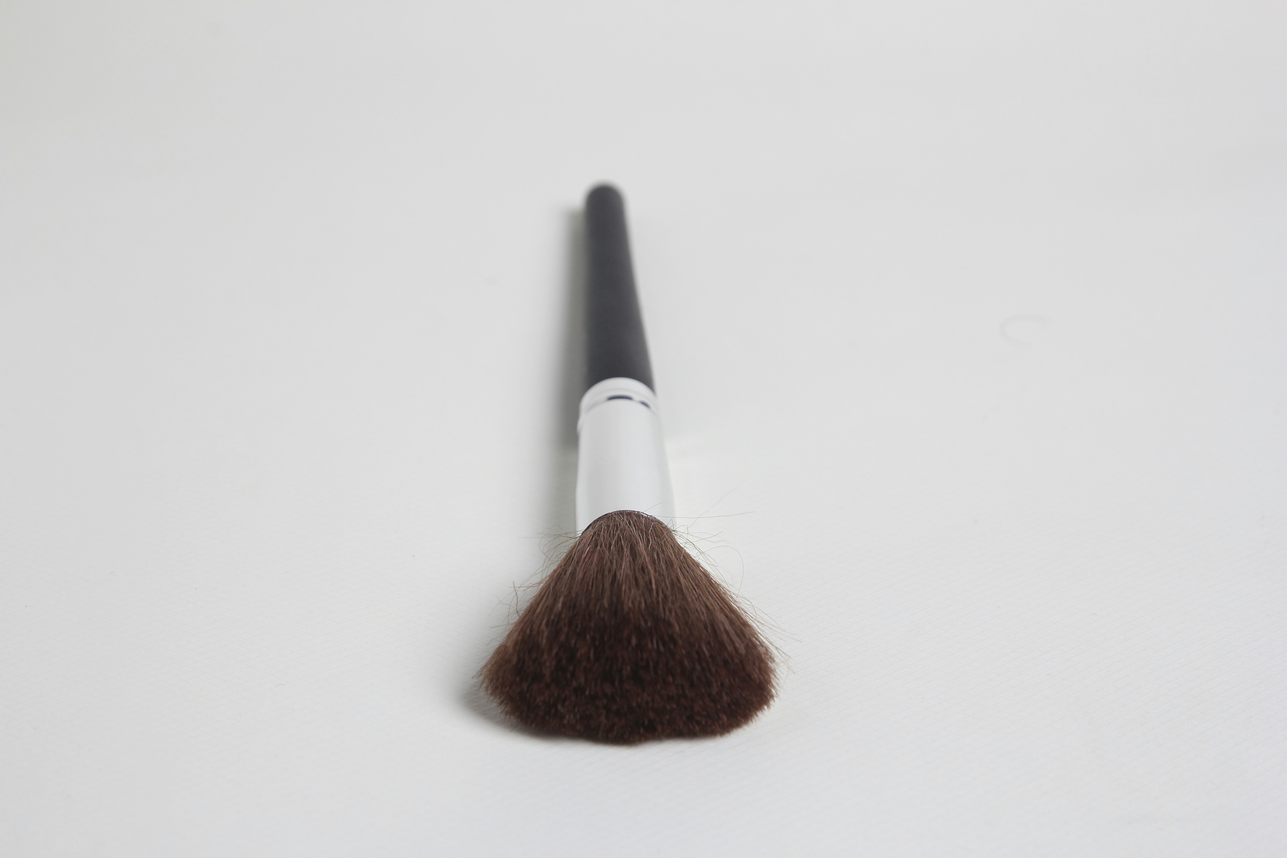 Quiet Precision: Studio Makeup Brush on White Space