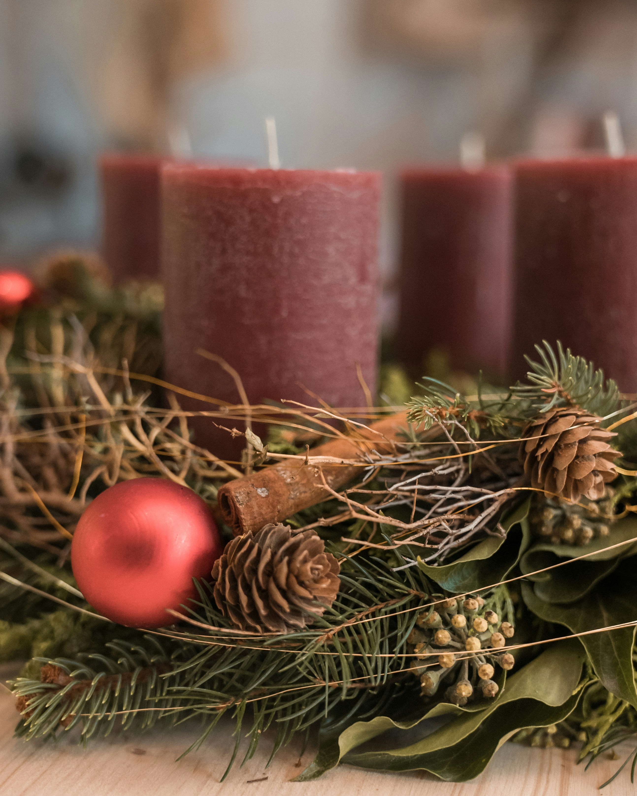 Advent of Greenery: Candles and Pineconed Centerpiece in Soft Focus